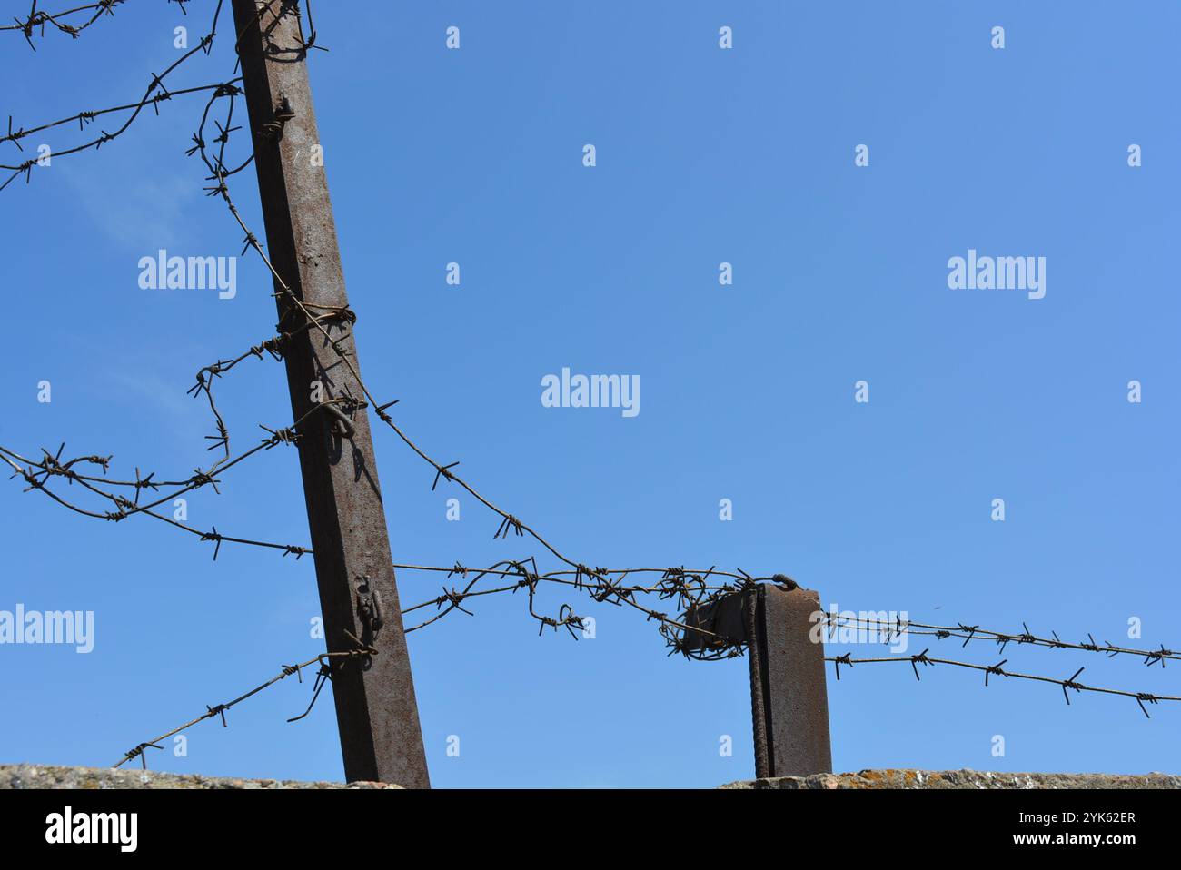 Old metal, red wire with metal pins, sharp ends against thieves is ...