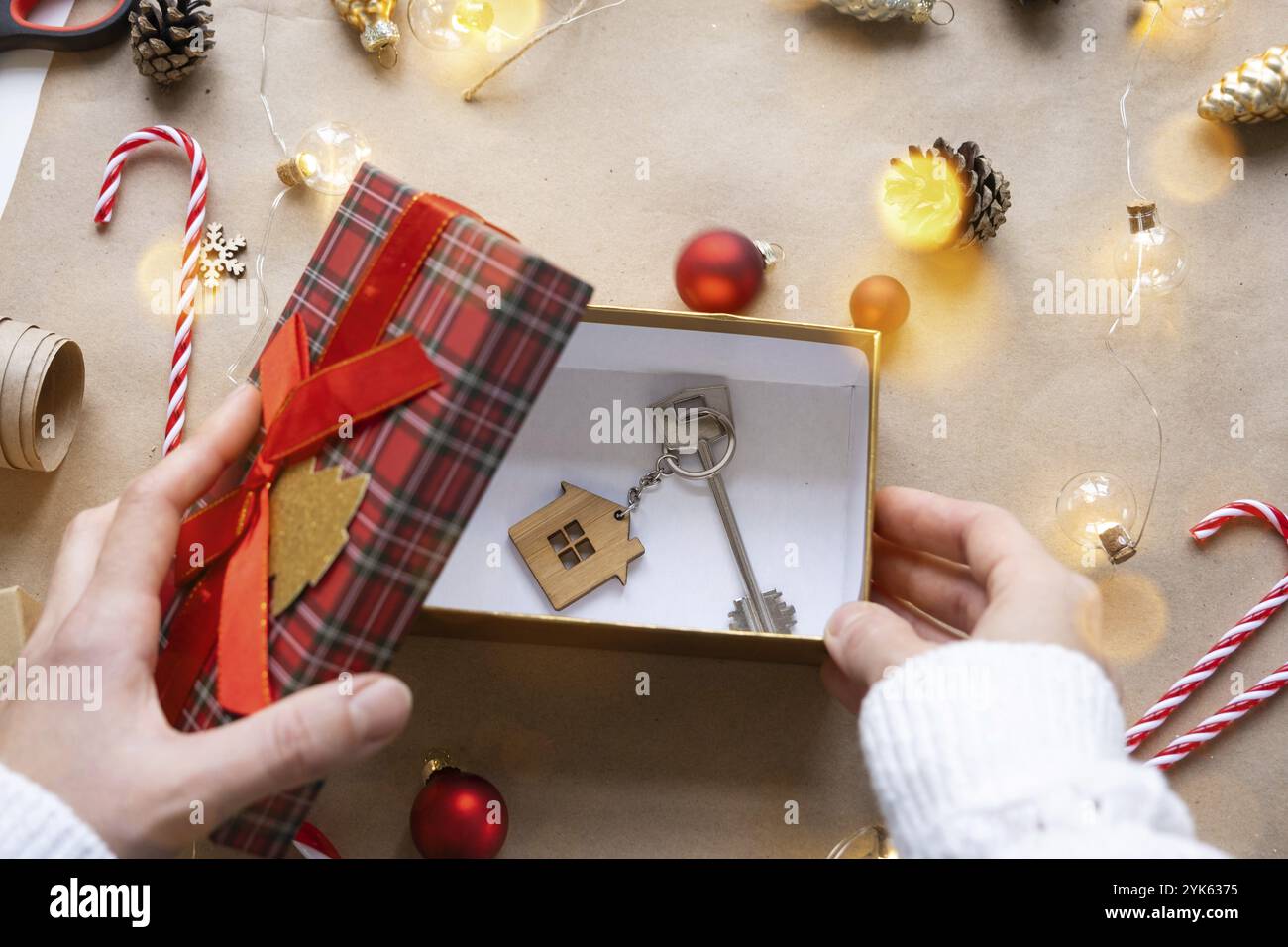 Key to house with keychain on cozy home in gift box with Christmas ...