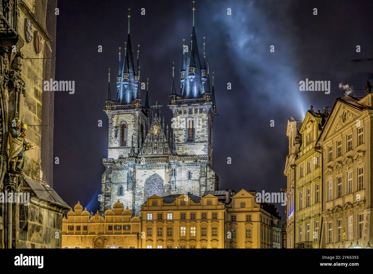 A Gothic church illuminated in the night sky, surrounded by historic ...