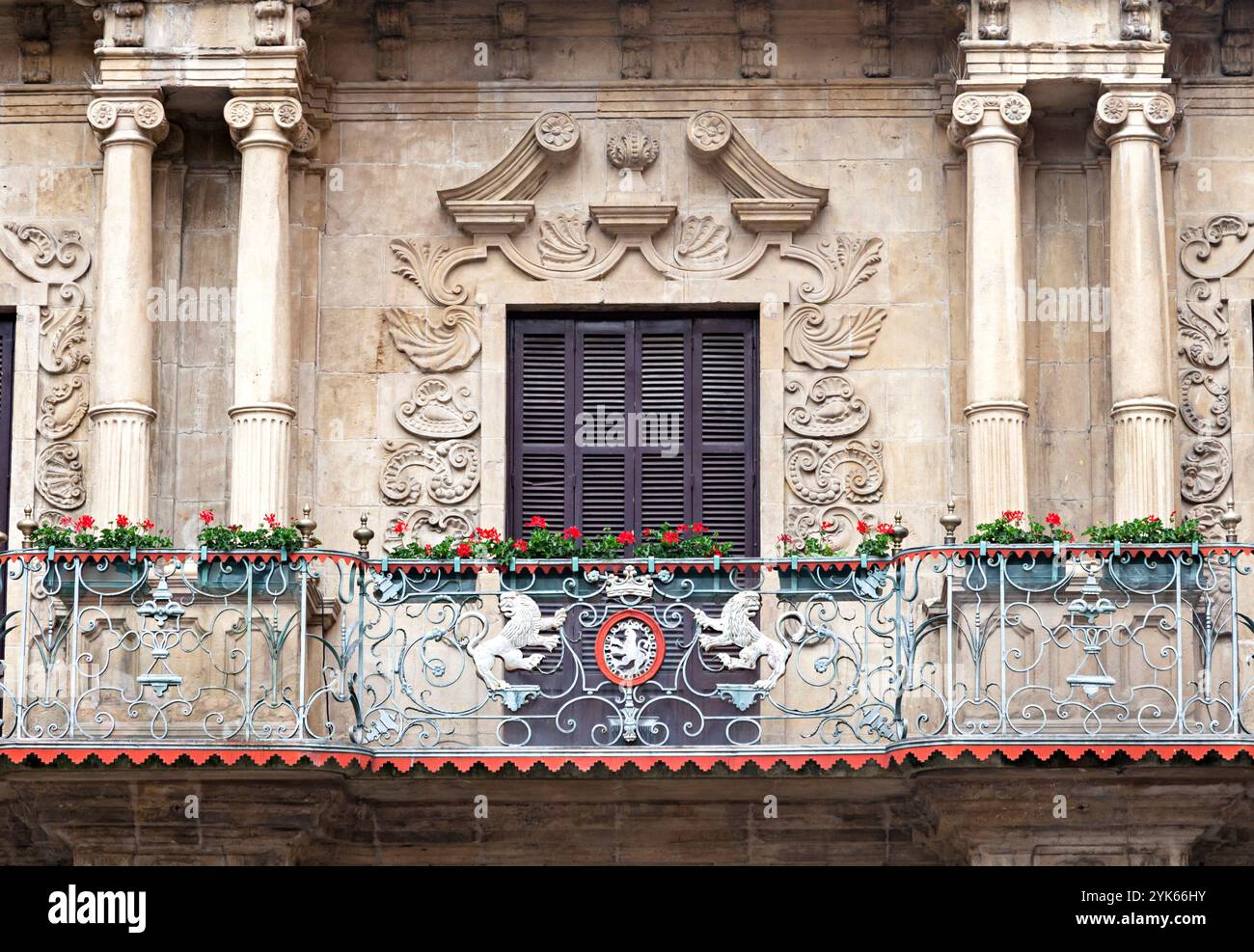 Intricate balcony railing adorned with flowers and carvings on a stone ...