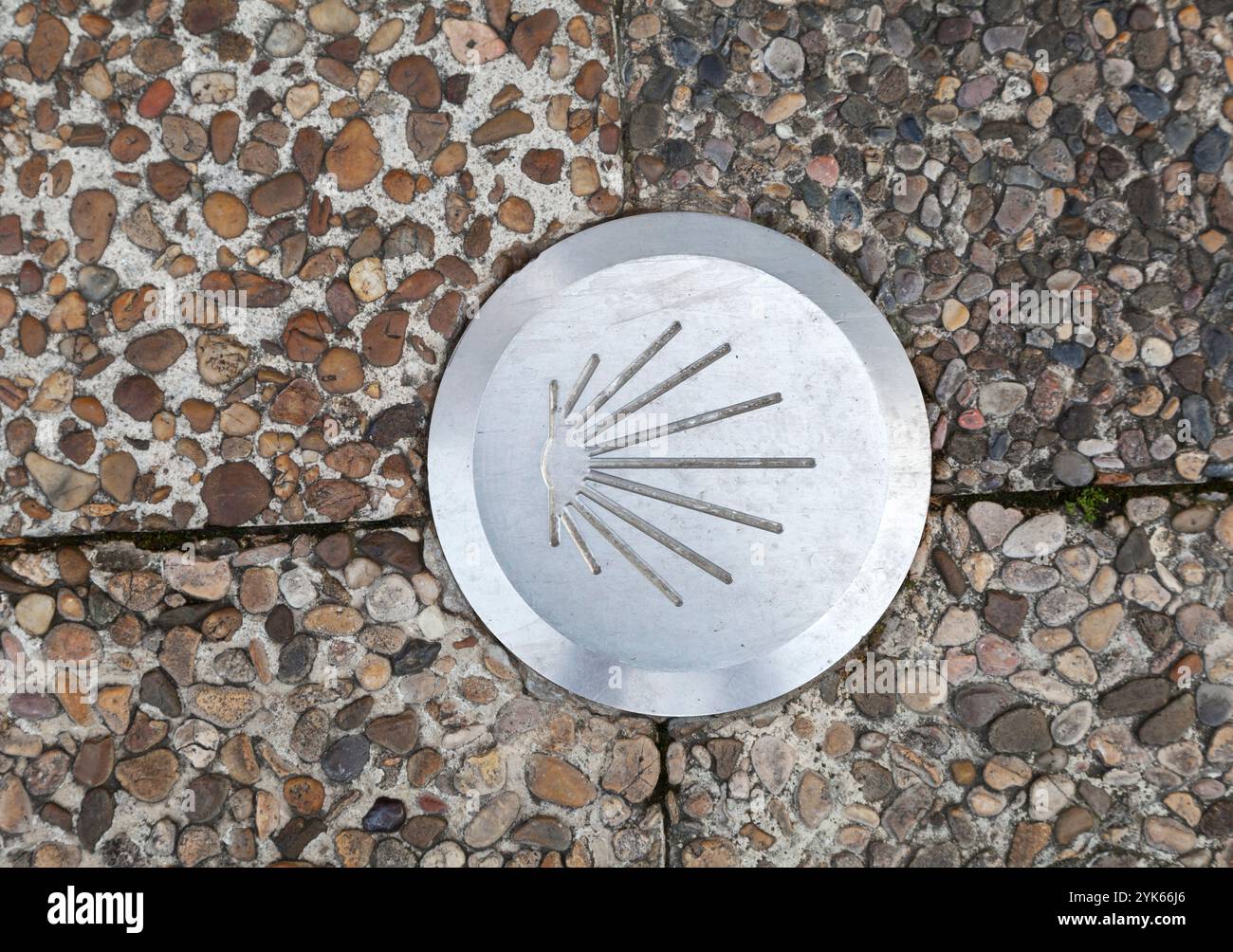 This bronze shell is set into a stone pathway, marking a trail at a ...