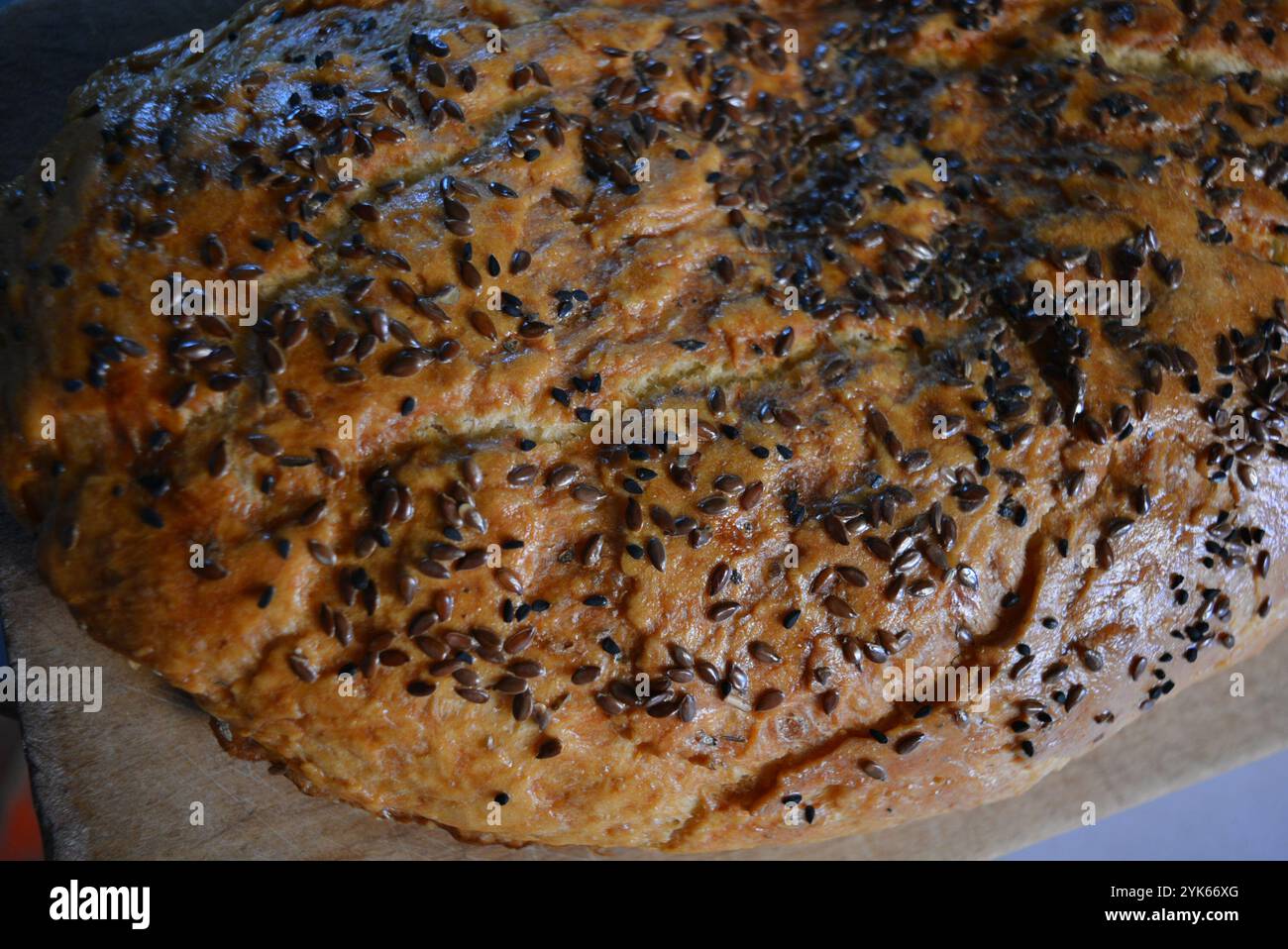 Fresh, delicious toasted bread made at home. A loaf of bread with black ...