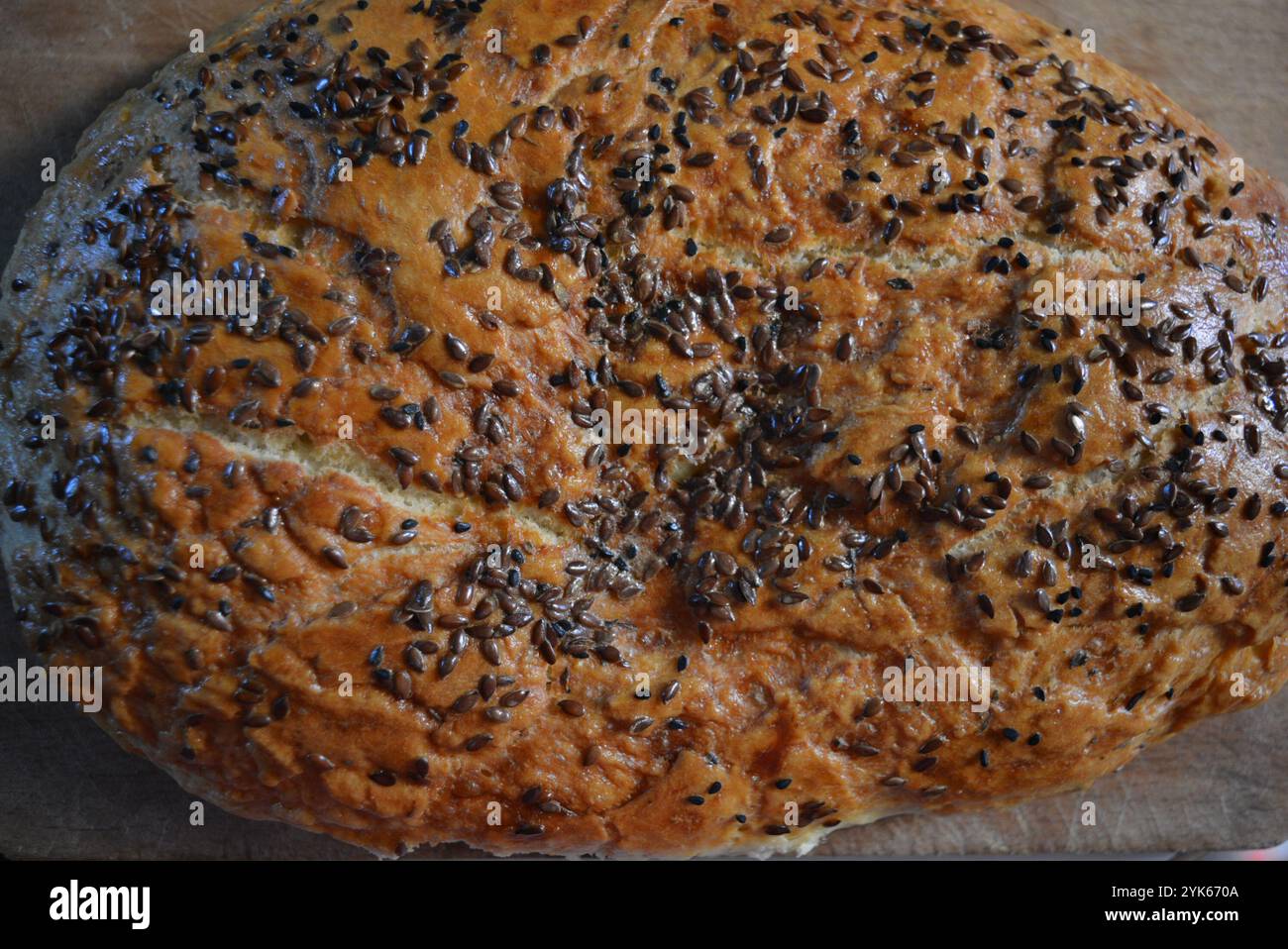 Fresh, delicious toasted bread made at home. A loaf of bread with black ...