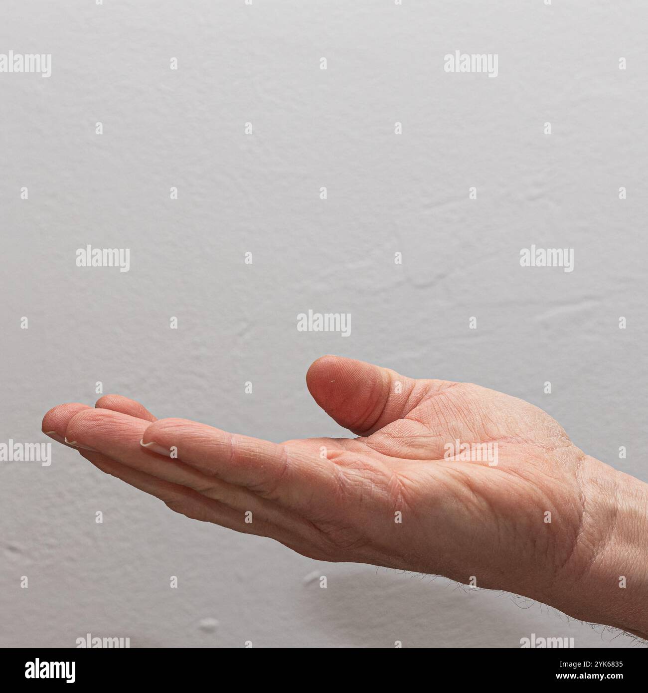 Open palm hand gesture against a white background, symbolizing openness ...