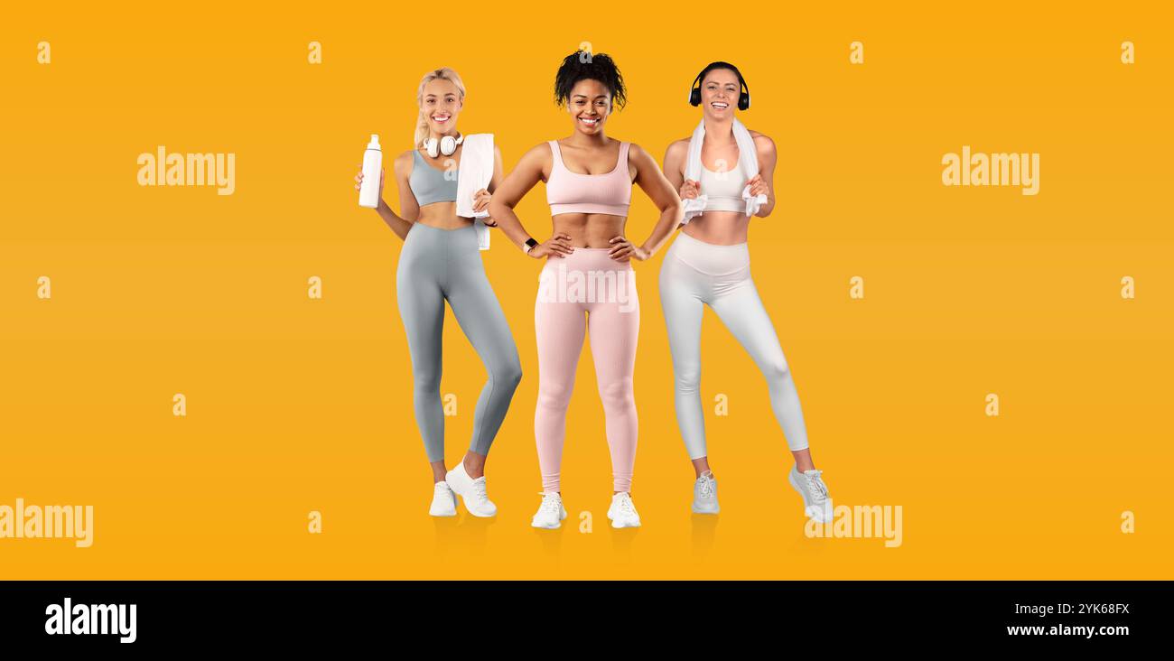 Three women in activewear pose confidently against a bright yellow ...