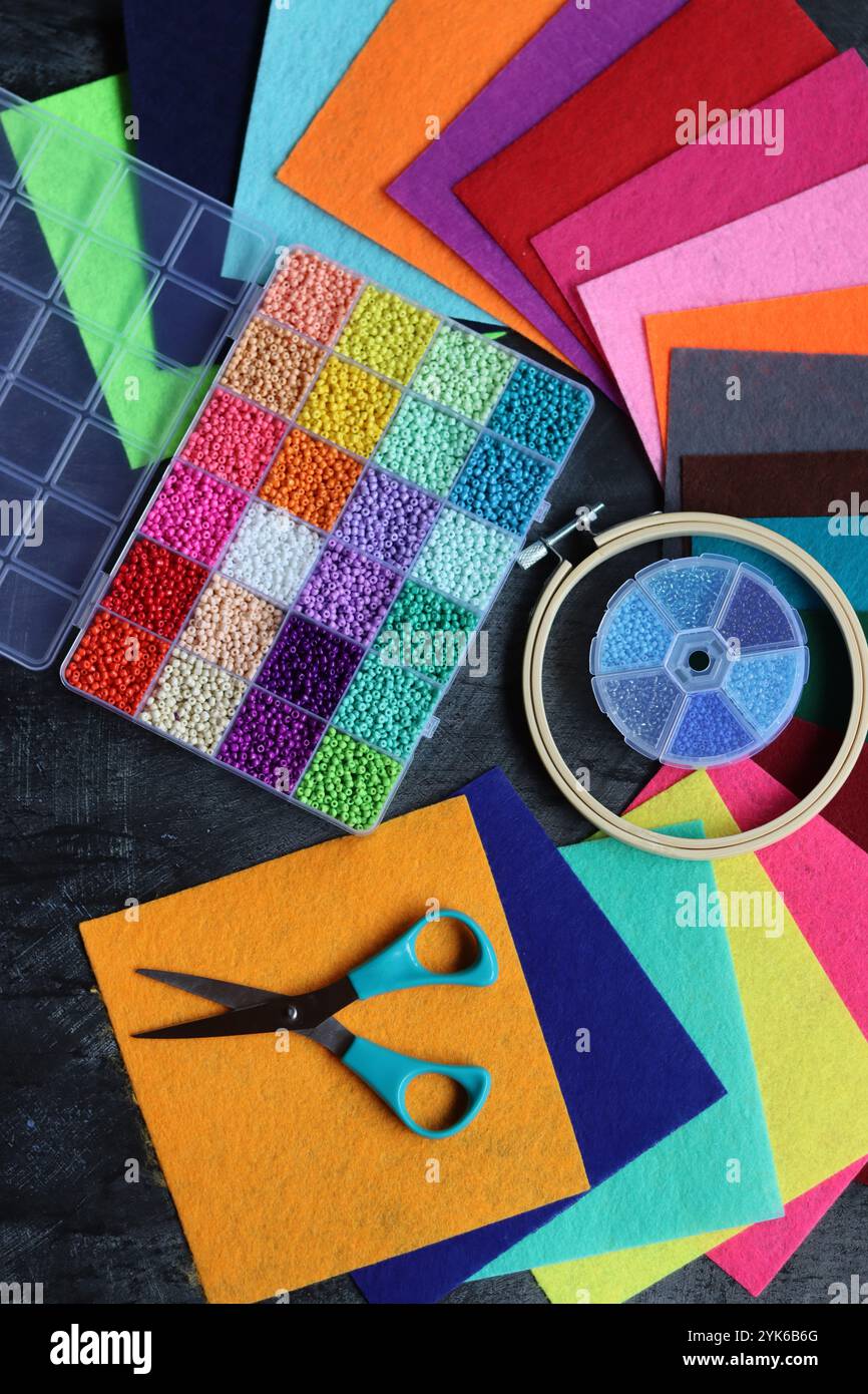 DIY project in making. Top view photo of colorful glass beads, felt ...
