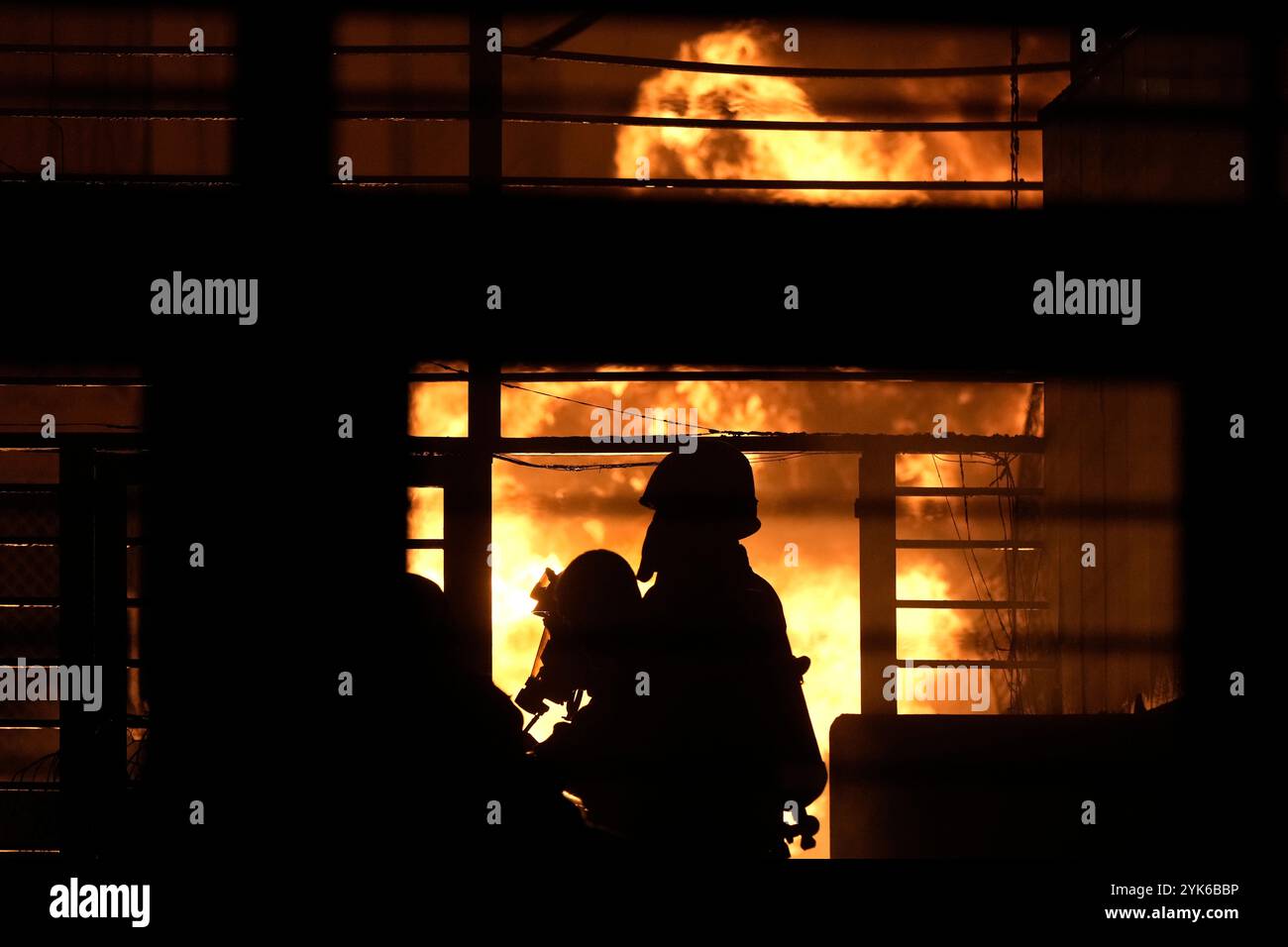 Firefighters extinguish a fire inside a computer shop hit in an Israeli ...