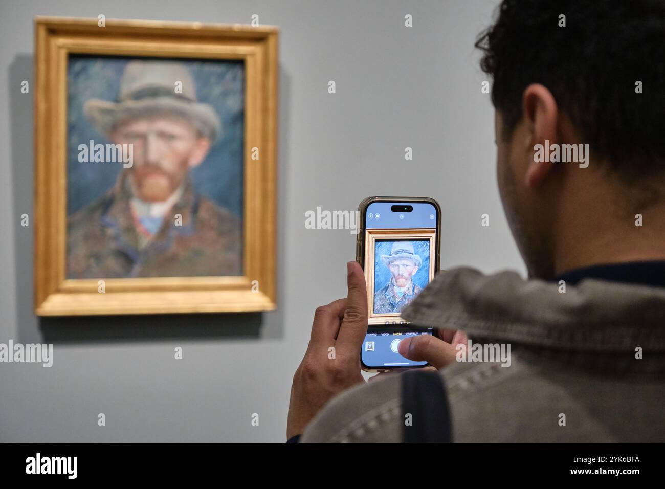 People taking photos of the self portrait painting of Vincent Van Gogh ...