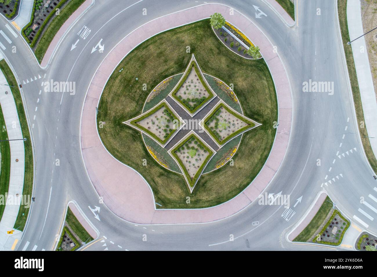 A round intersection with a grassy area in the middle Stock Photo - Alamy