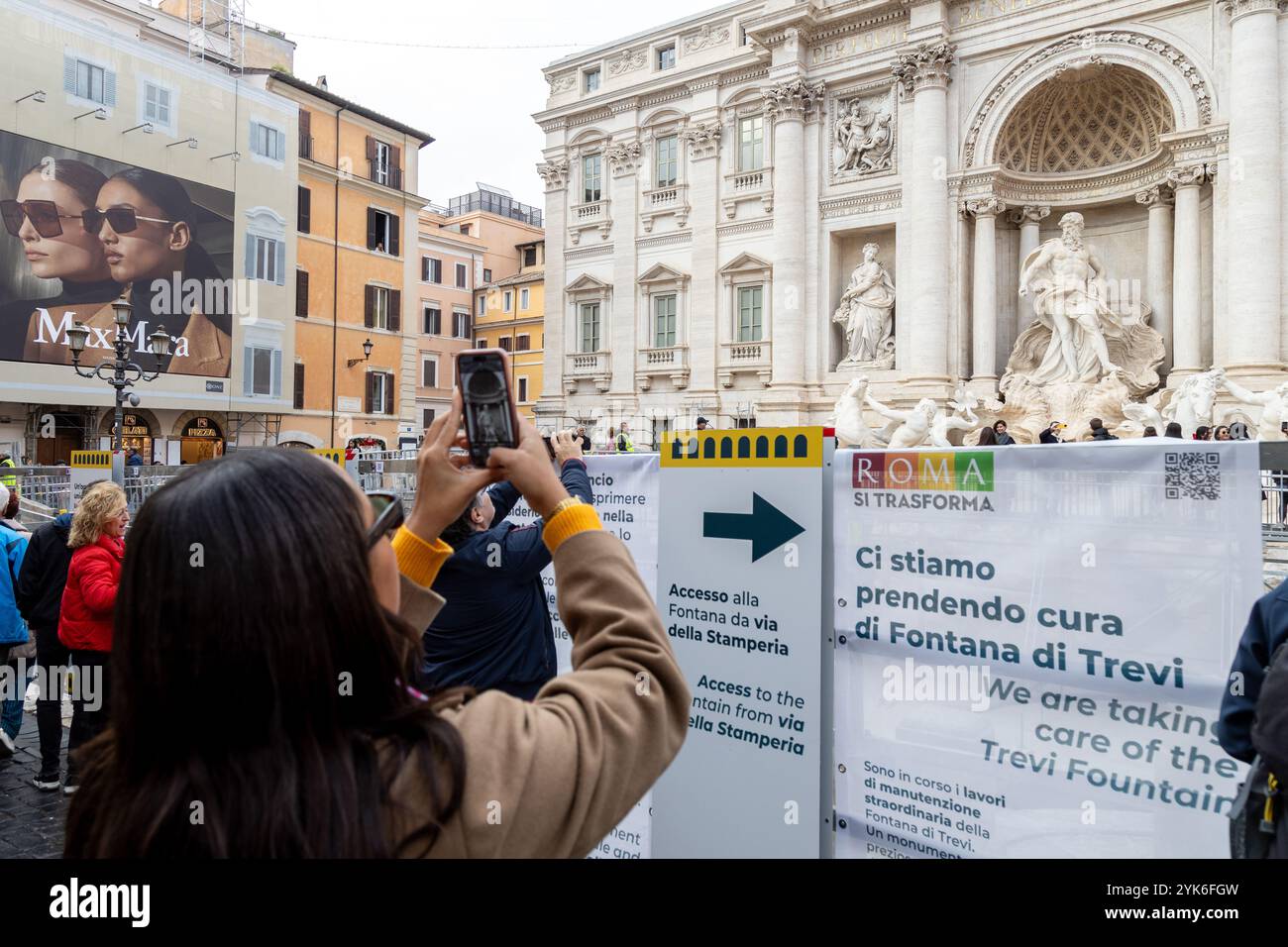 Rome, Italy - Nov 14th, 2024: A visitor photographs the Trevi Fountain ...
