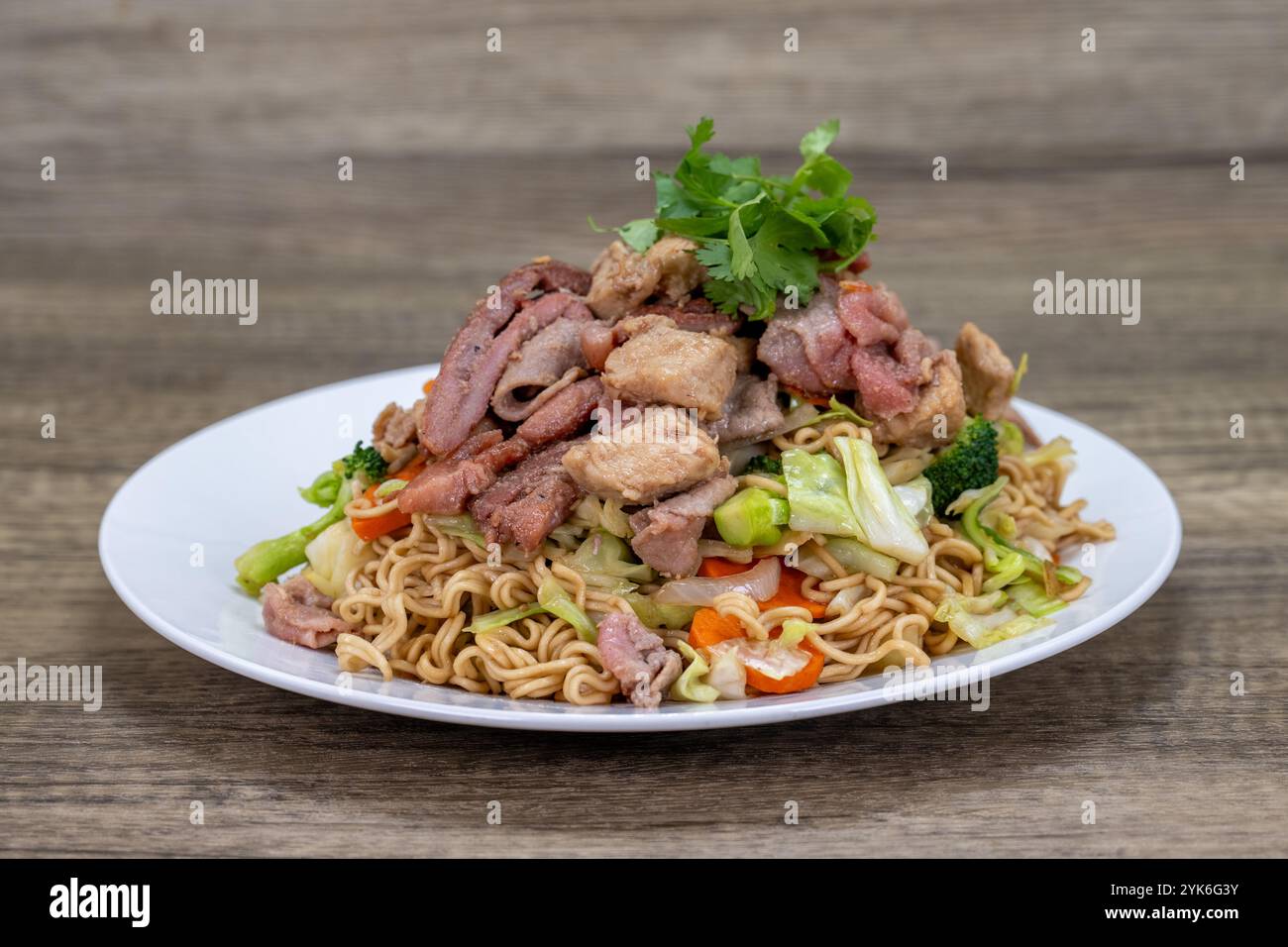 Beef Chow fun rice noodles piled high on the plate for a hearty ...