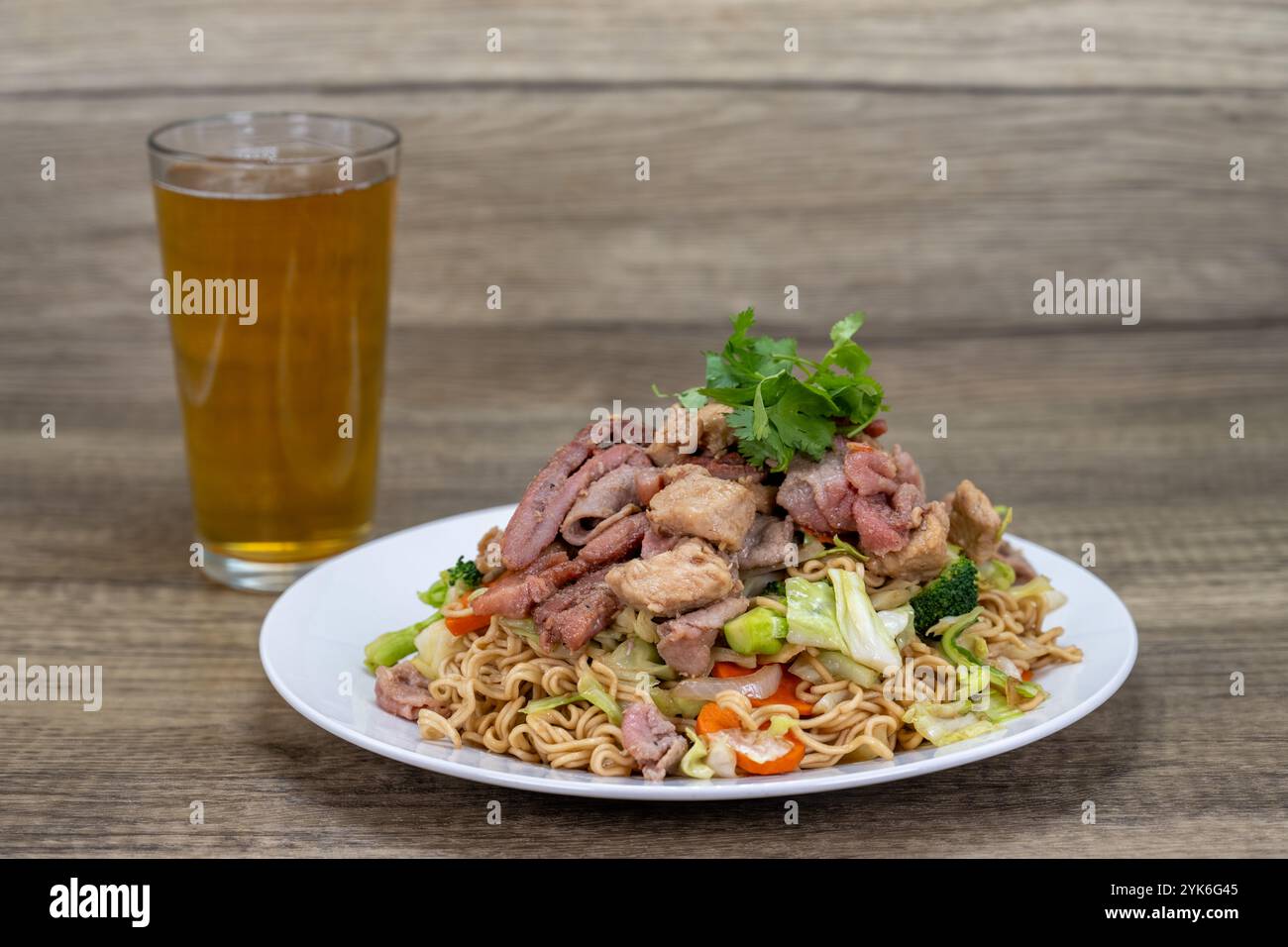 Beef Chow fun rice noodles piled high on the plate for a hearty ...