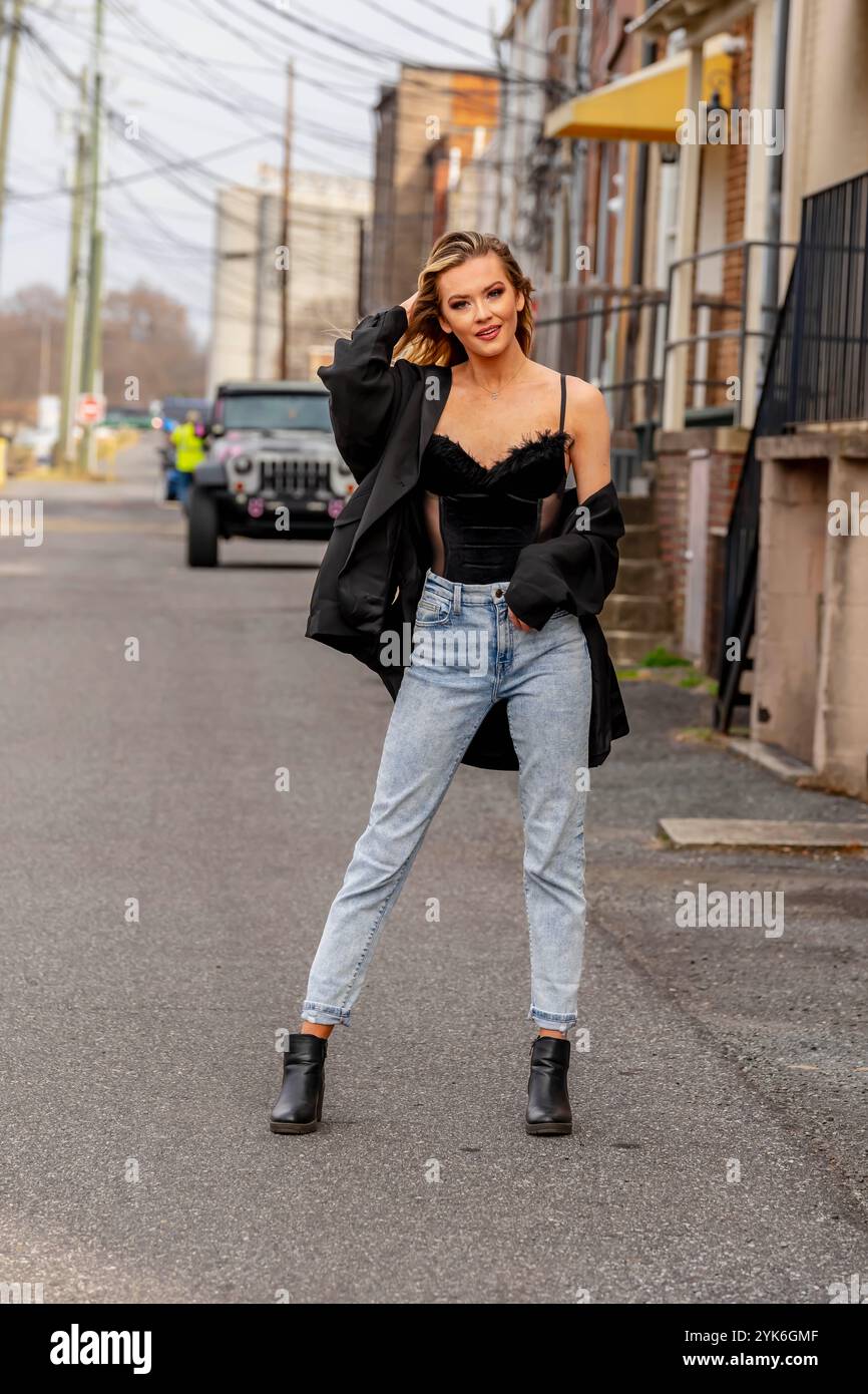 A gorgeous blonde woman strolls through a quaint small town, wrapped in ...