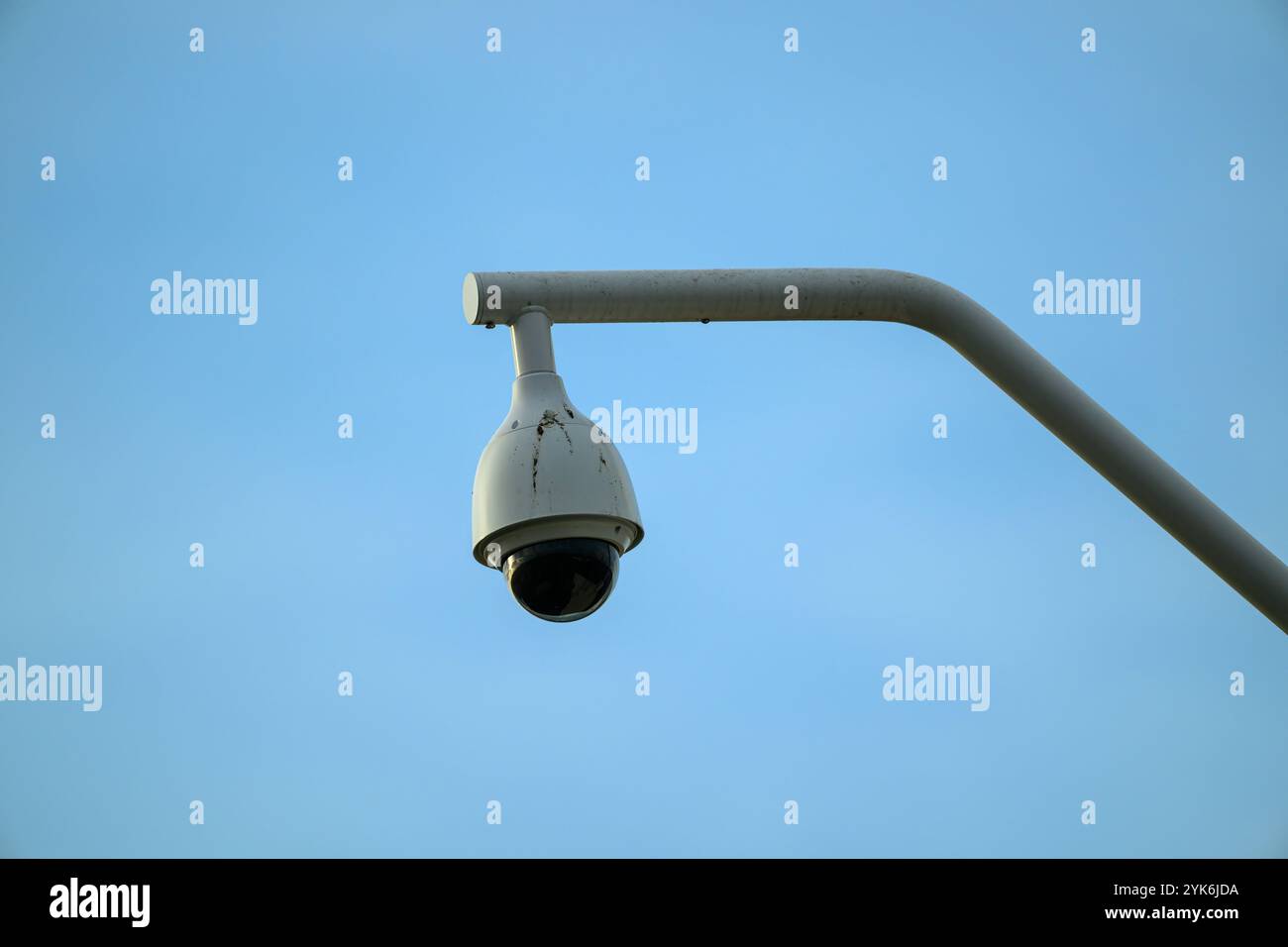 A surveillance camera is positioned on a pole, capturing visuals in an ...
