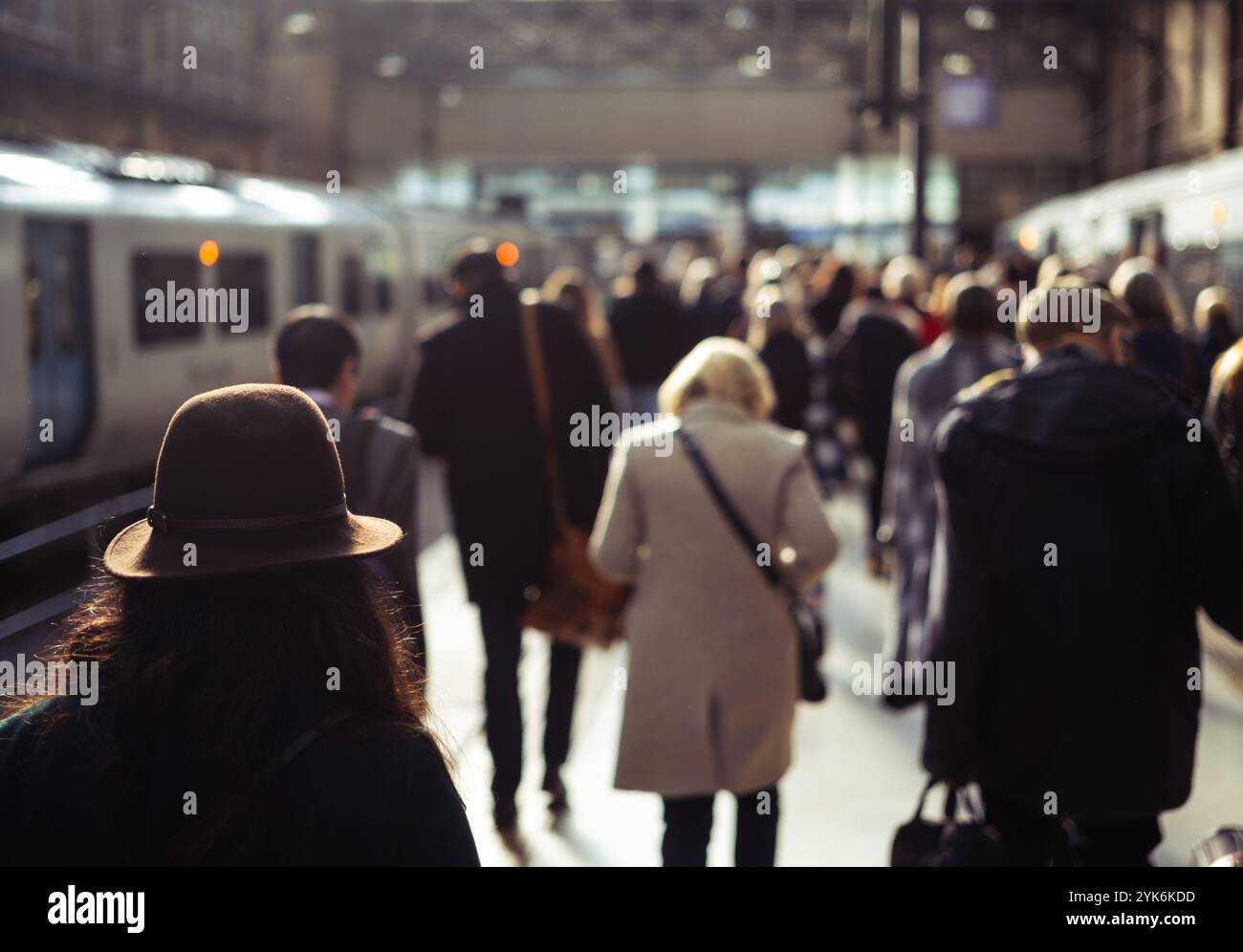 A Crowd Of People Disembarking From A Train Stock Photo - Alamy