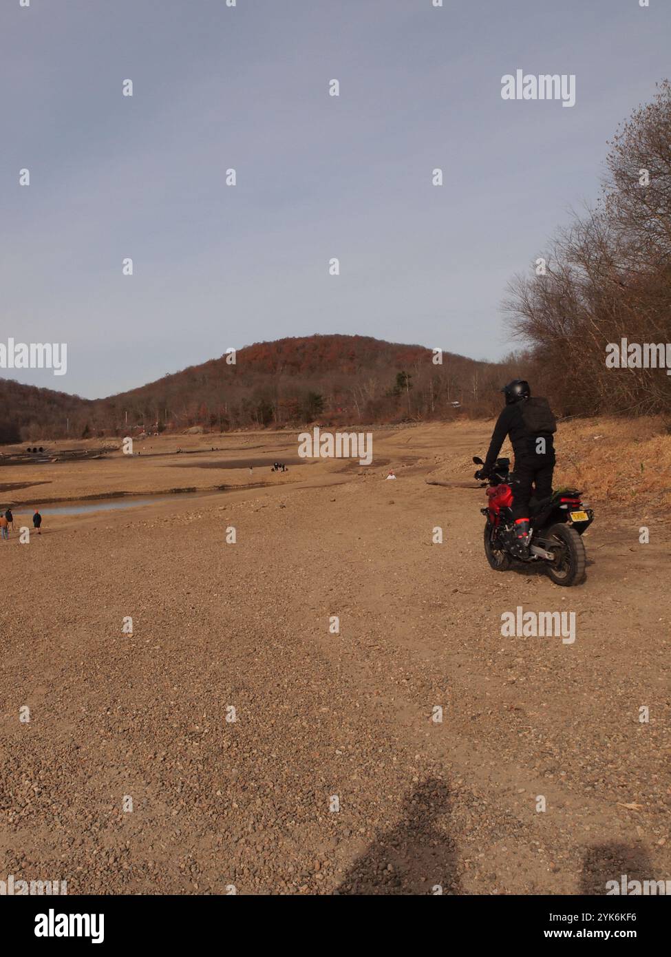 Motorcycle rider entering an empty lake bed hi-res stock photography ...