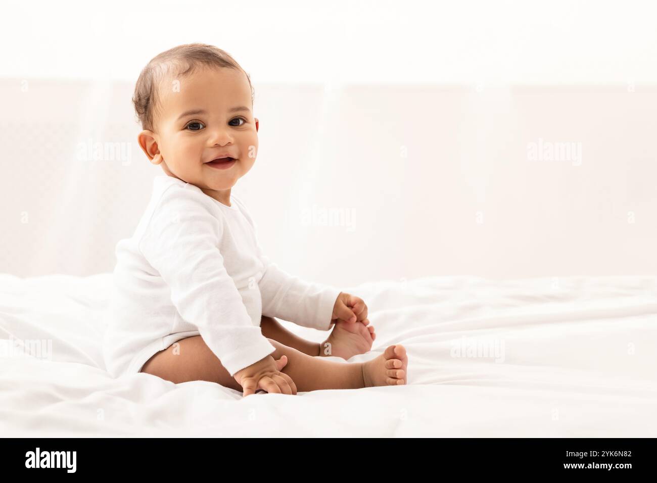 Beautiful African Baby Boy Sitting In Bed Posing In Bedroom Stock Photo ...