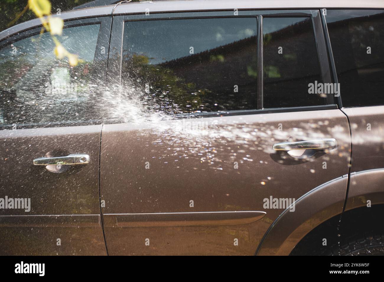 Washing your SUV car with a hose at home in your backyard Stock Photo ...