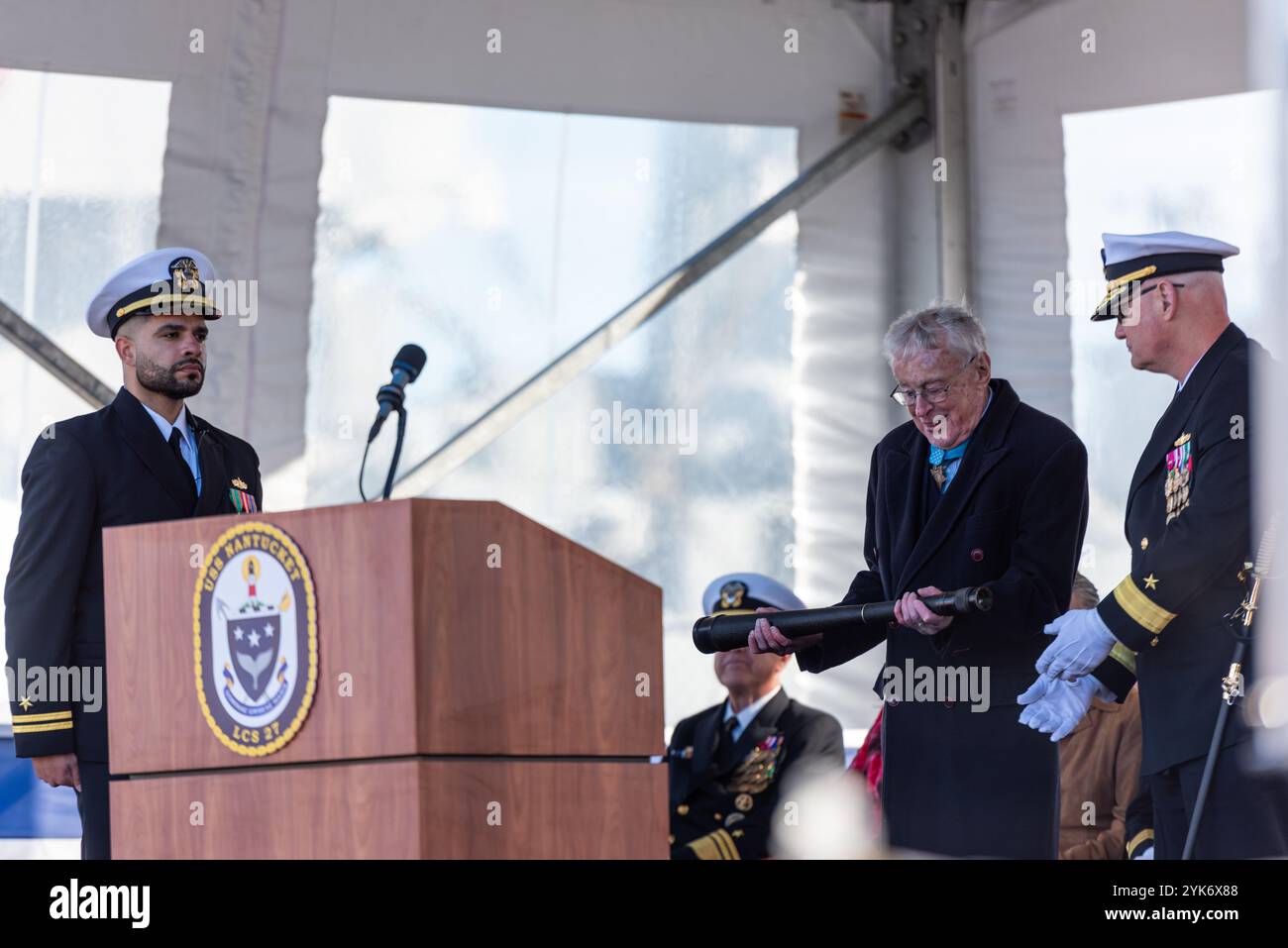 Retired Navy Captain Thomas Kelley about to present the long glass to ...
