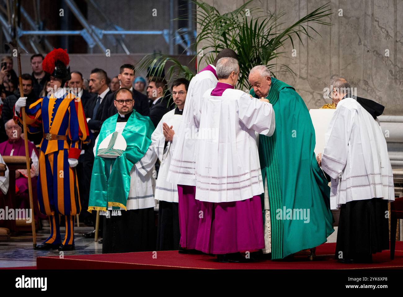 Pope Francis is helped to put on his sacred vestments to preside over ...