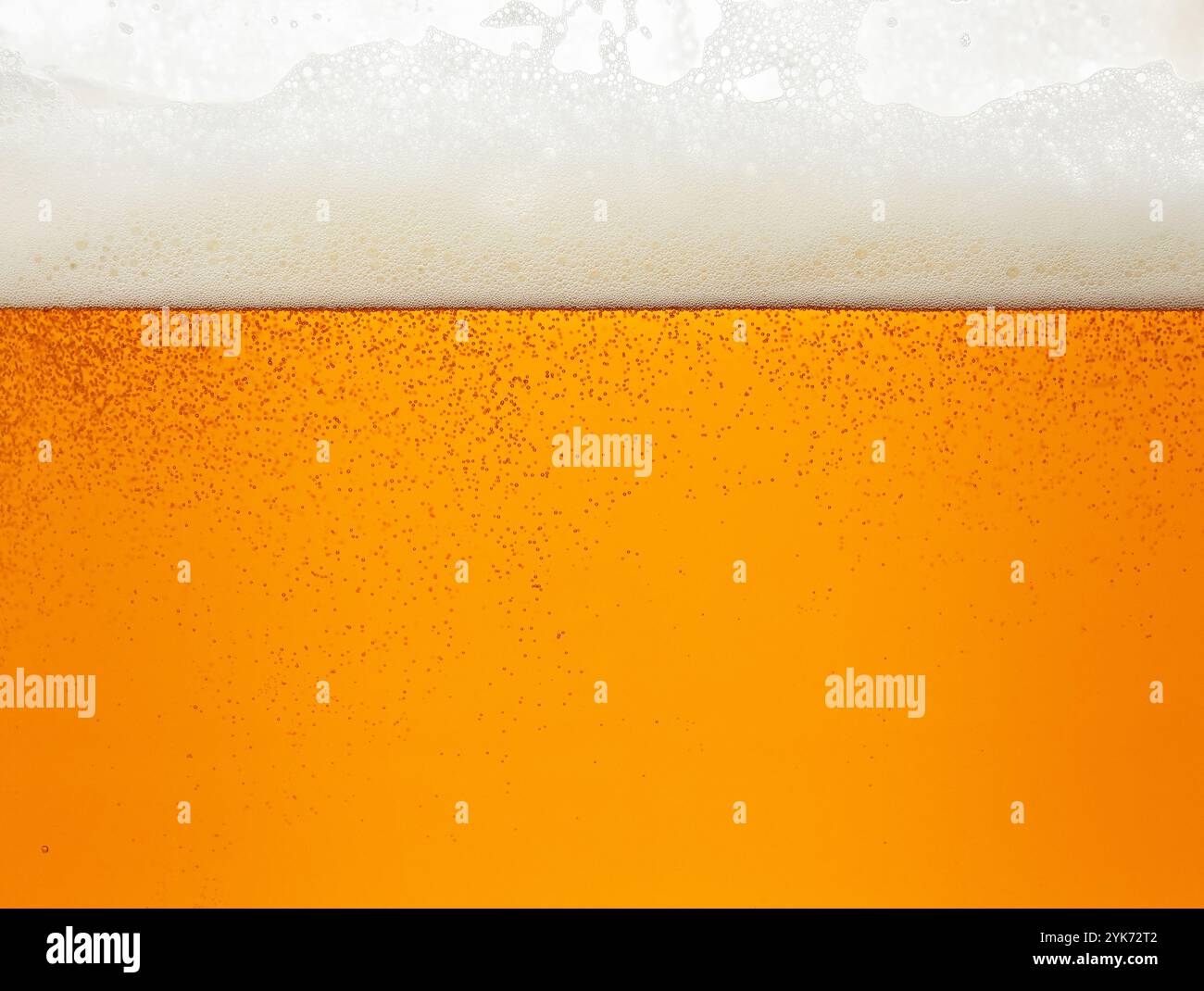 Close up background texture of lager beer with bubbles and froth ...