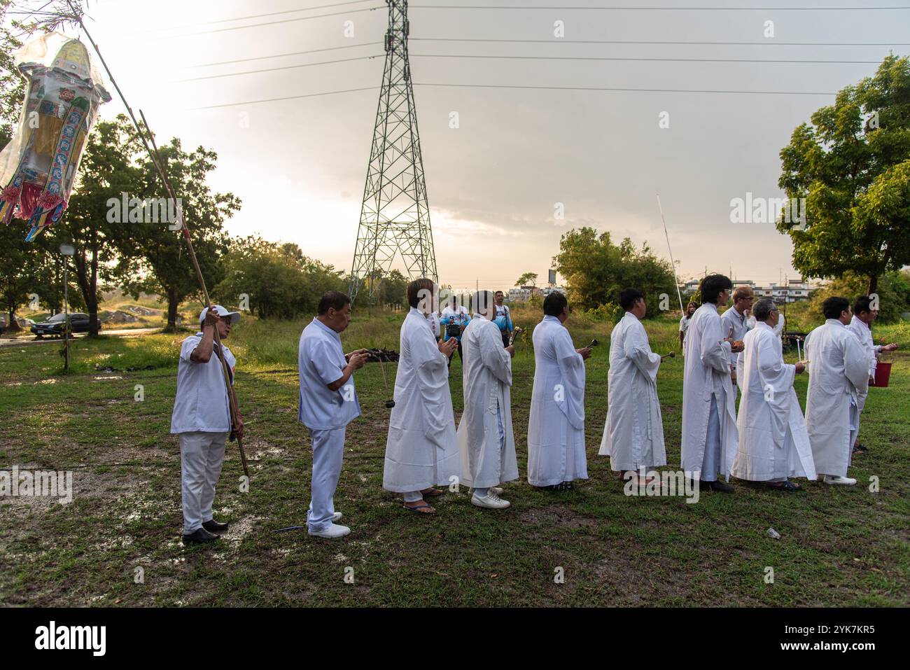 Volunteers parade for a ritual during the cemetery cleansing ceremony ...