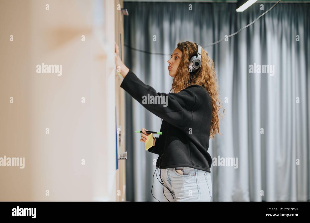 Focused student writing on board in modern school classroom Stock Photo ...