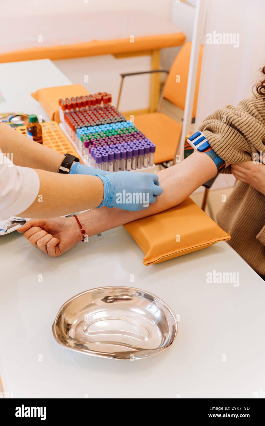 Medical professional performing blood draw procedure with precision in ...