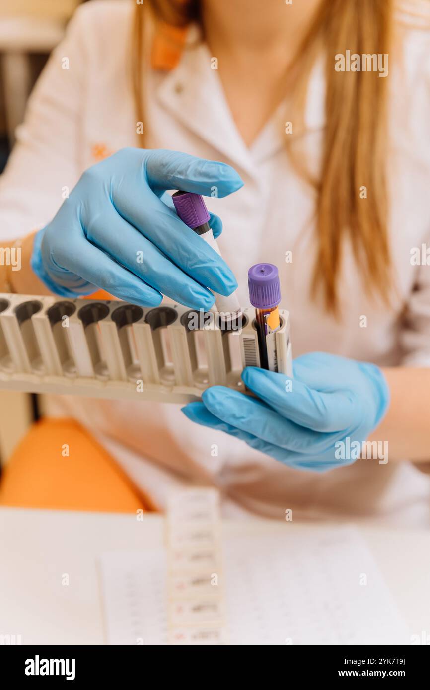 Lab technician handling blood samples with precision and care for ...