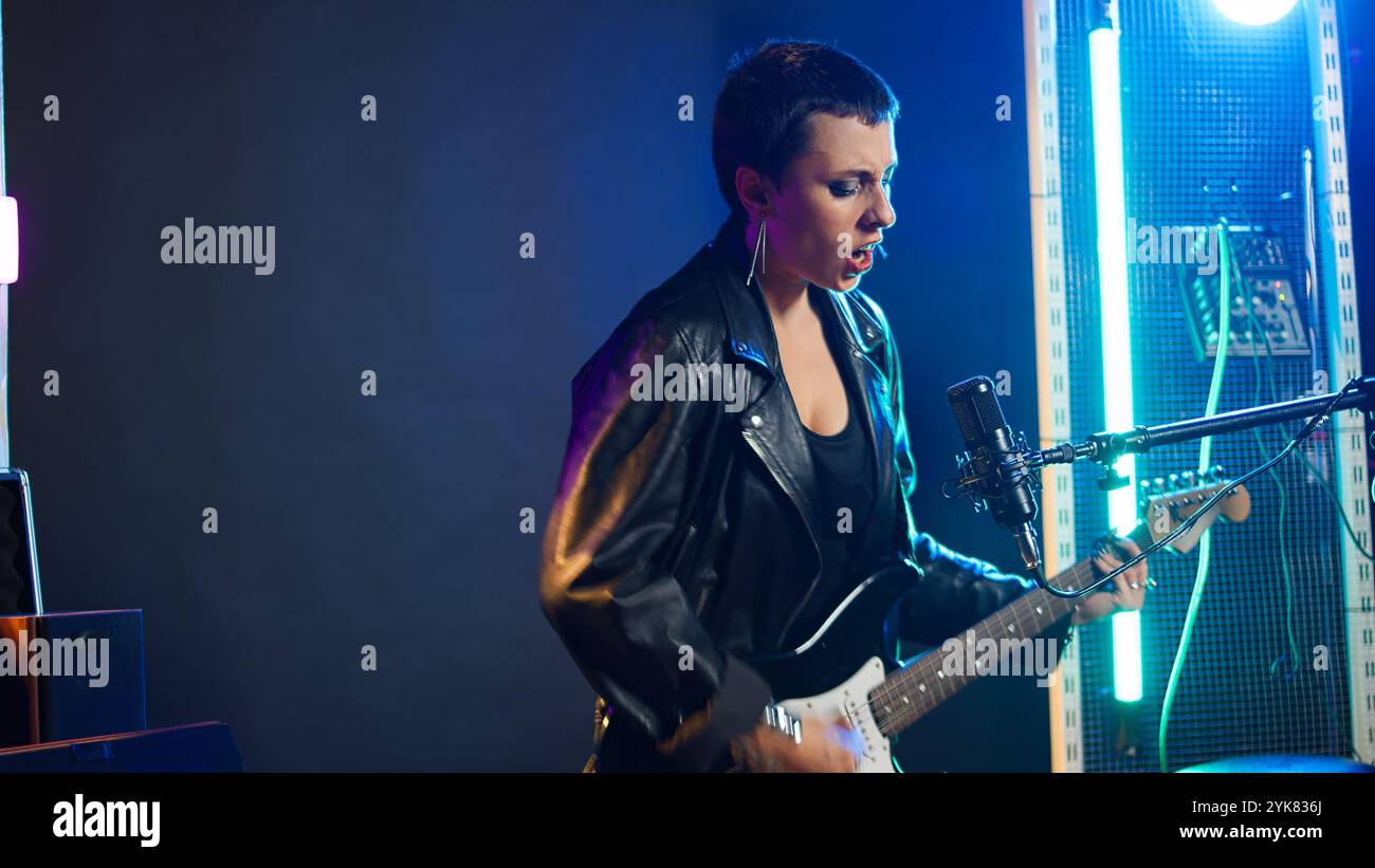 Fierce rocker woman sings and plays bass guitar in a heavy metal ...