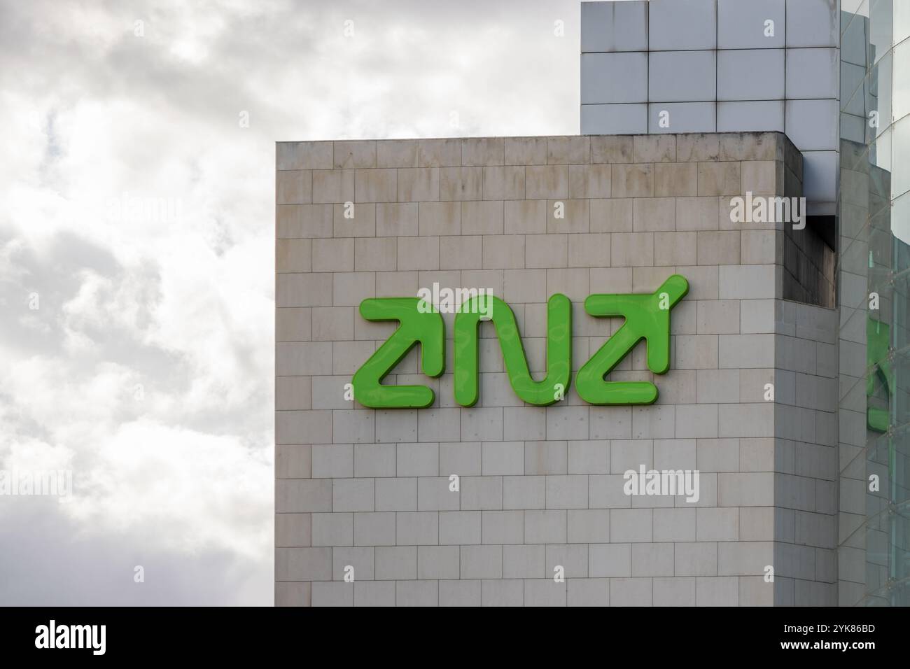 Green anz bank logo with stylized arrow pointing upward, affixed to the ...