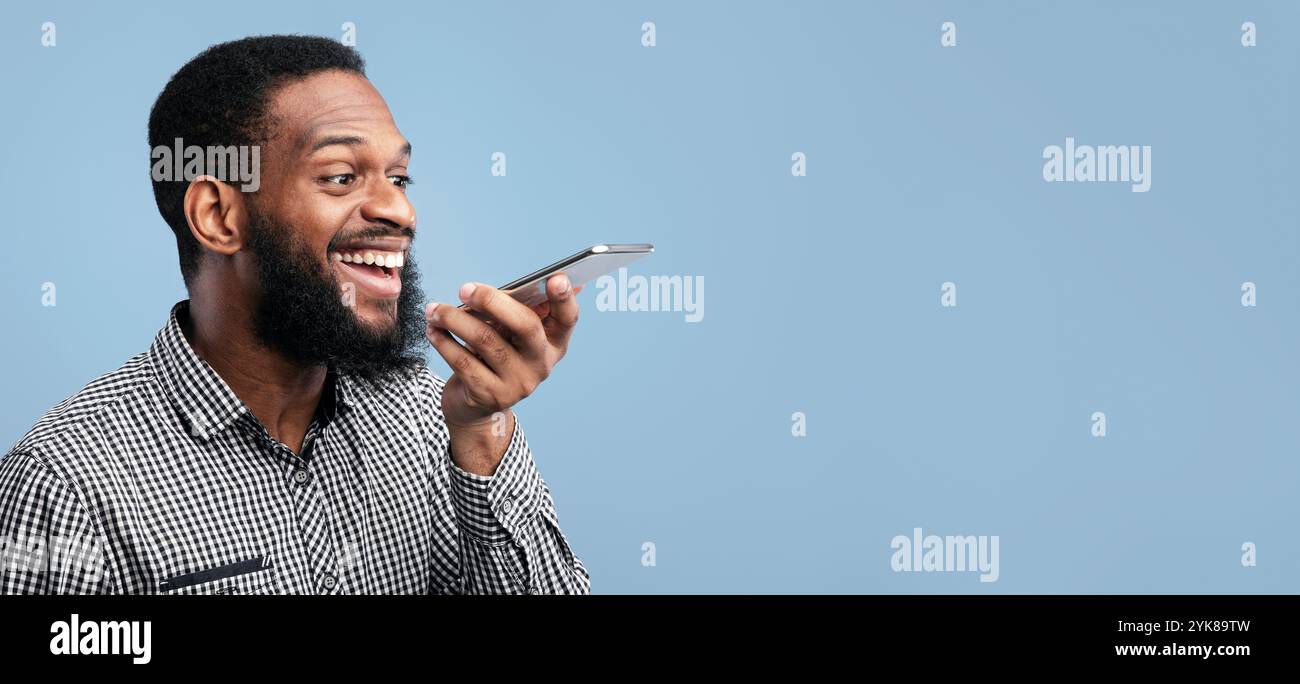 Happy afro man using voice assistant on smartphone Stock Photo - Alamy