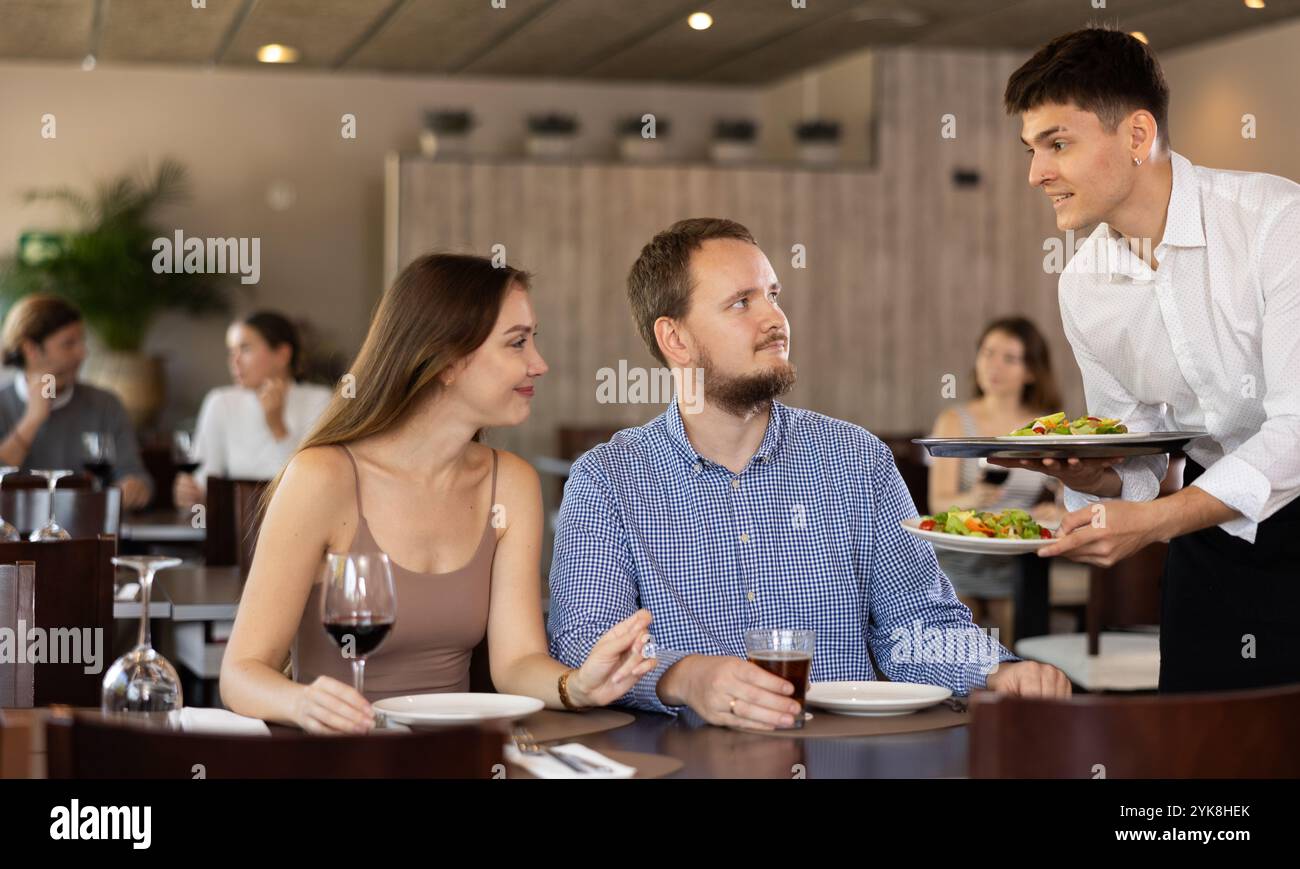 Male waiter brings dishes hi-res stock photography and images - Alamy