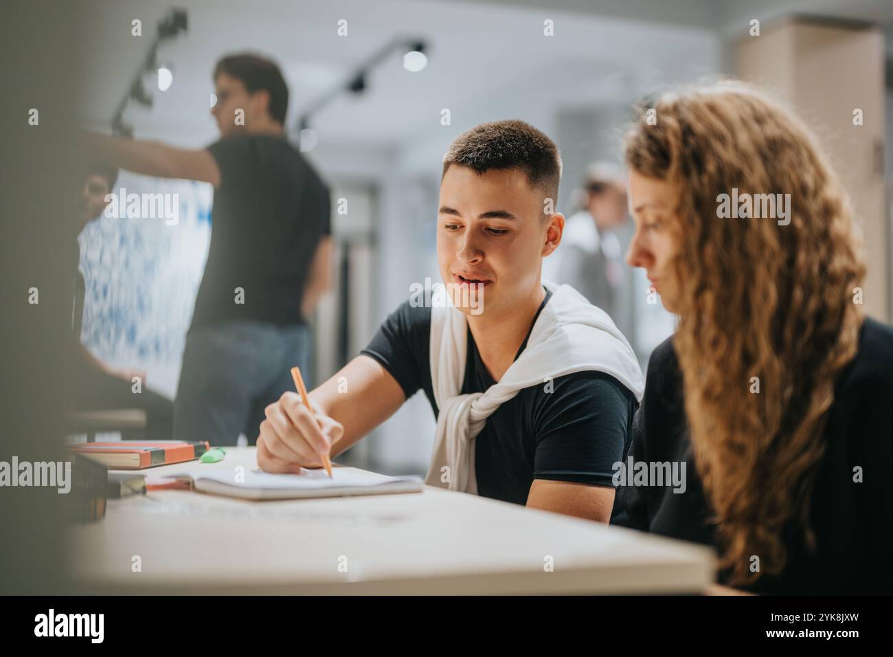 High school students collaborating on a project in a classroom setting ...