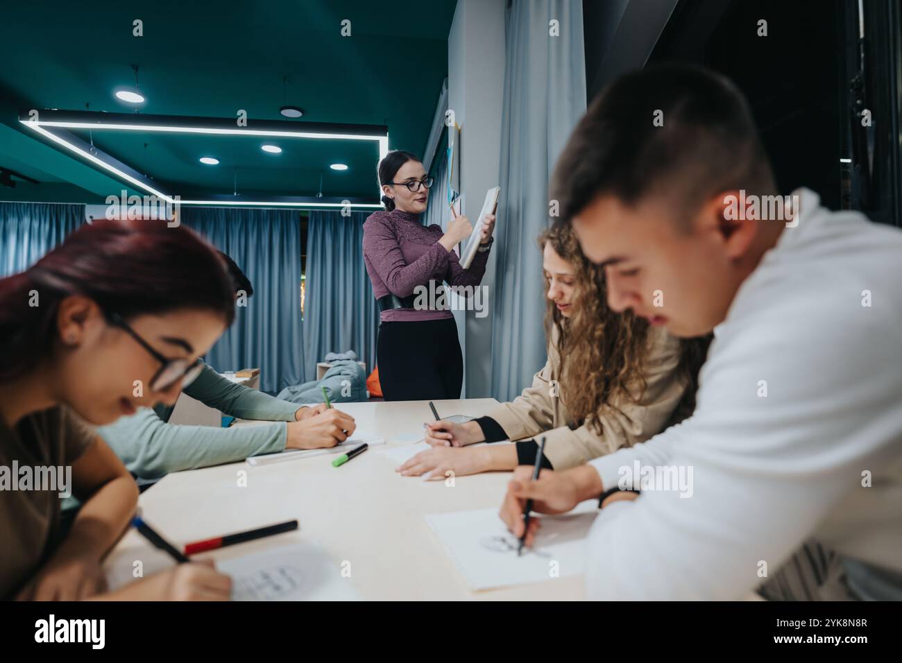 Group of diverse students collaborating in a modern classroom setting ...