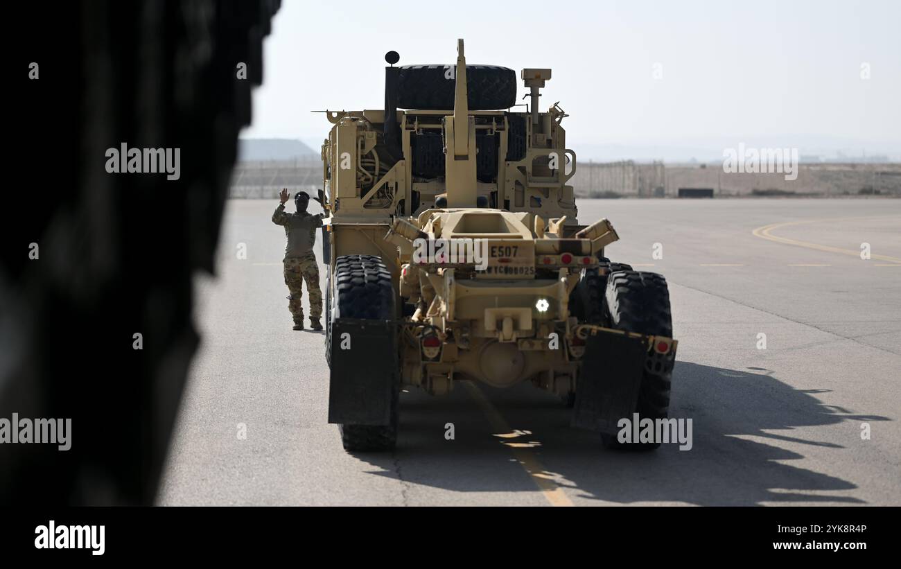 A U.S. Air Force loadmaster guides a vehicle onto a C-17 Globemaster ...