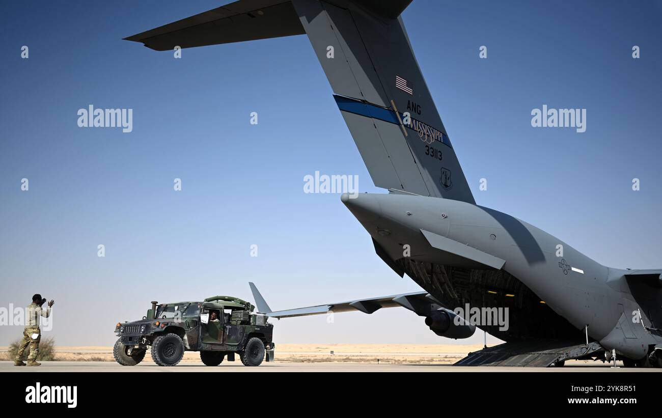 A U.S. Air Force loadmaster guides a vehicle onto a C-17 Globemaster ...
