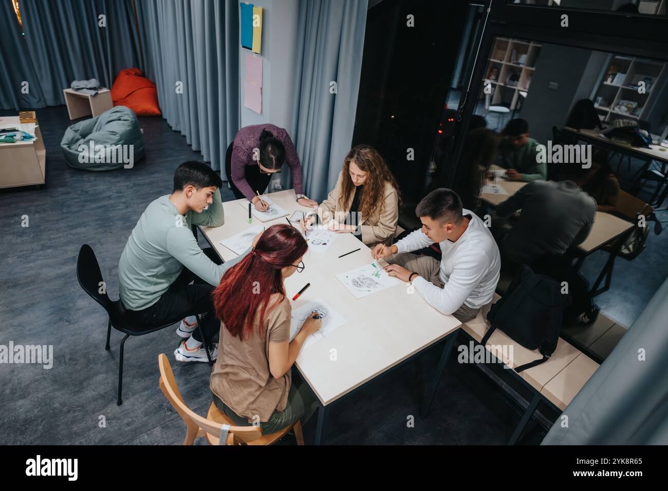 Group of students collaborating in a modern classroom setting Stock ...