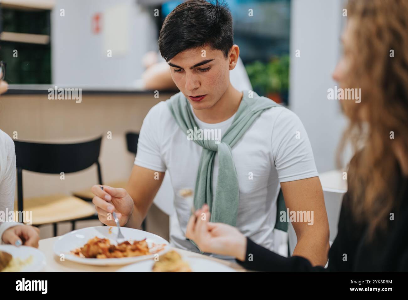 Friends eating together at canteen hi-res stock photography and images ...