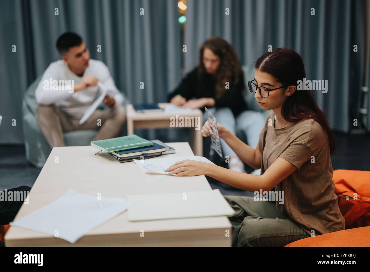 Group of students studying together at school with a focus on a young ...