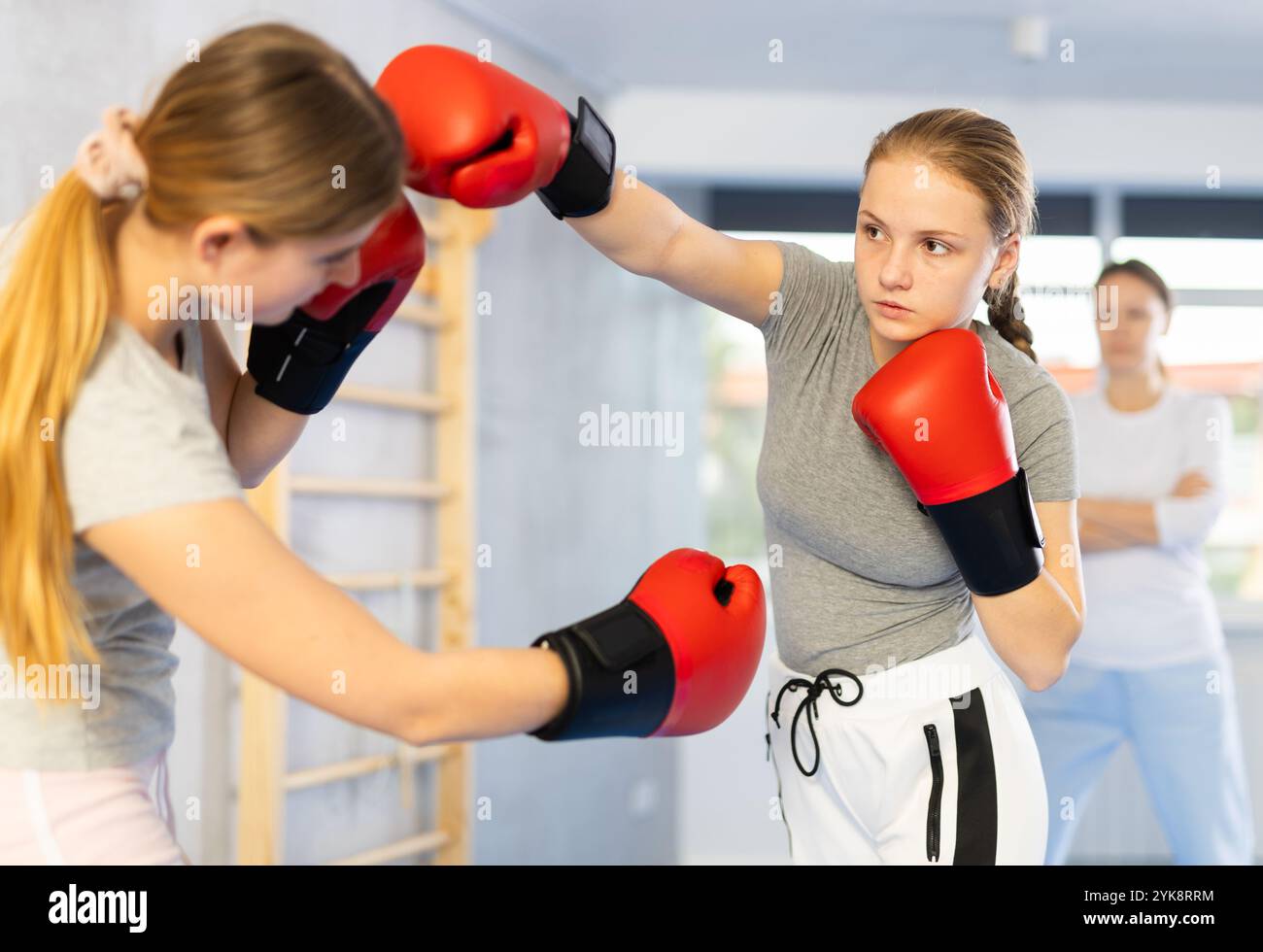 Teen girls in punch mitts boxing Stock Photo - Alamy