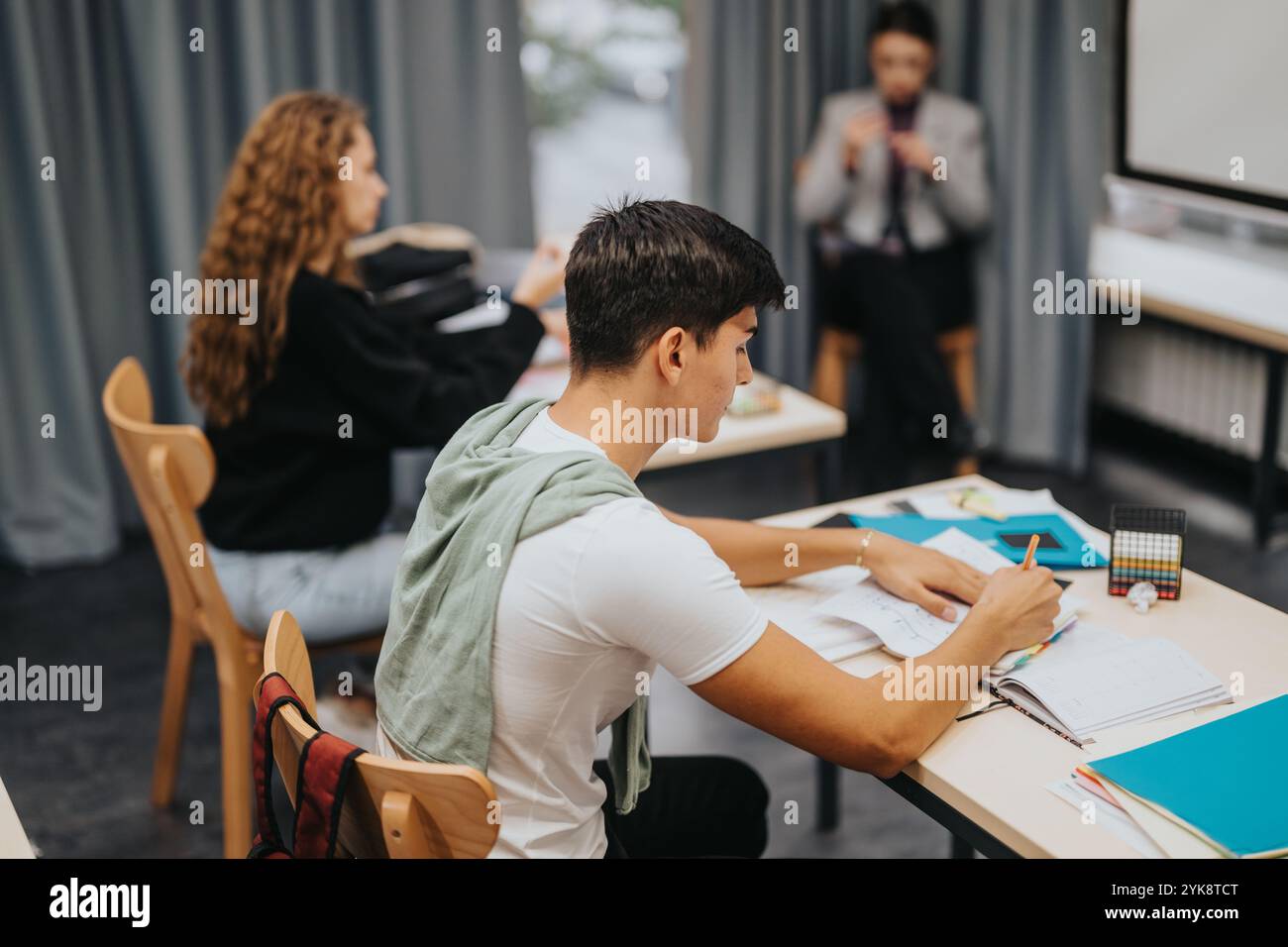 Focused students engaged in classroom learning activities Stock Photo ...