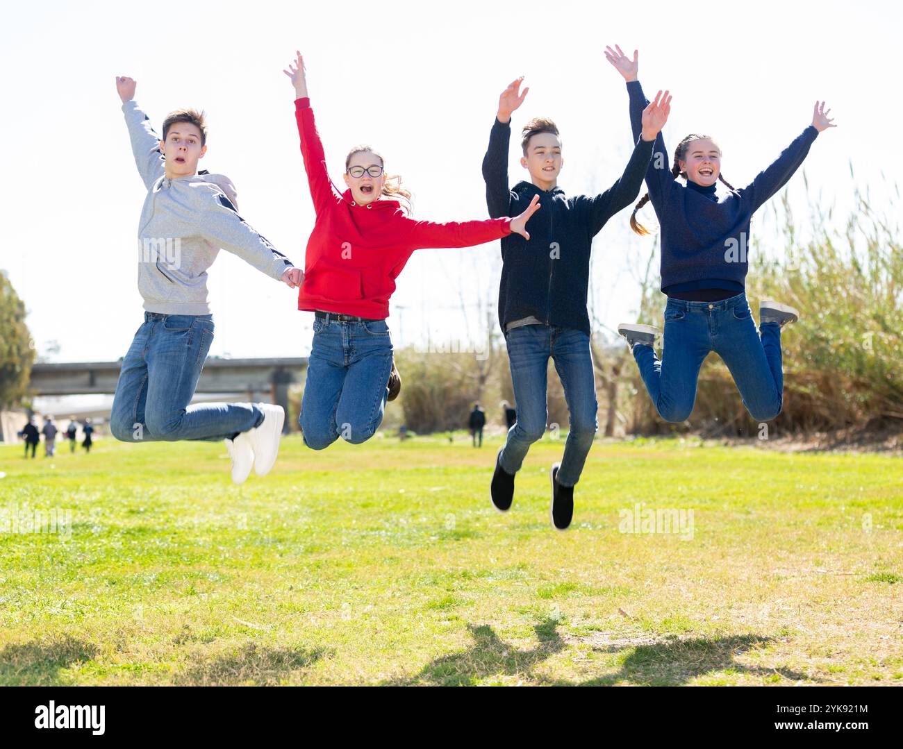 Portrait four happy friends jumping hi-res stock photography and images ...