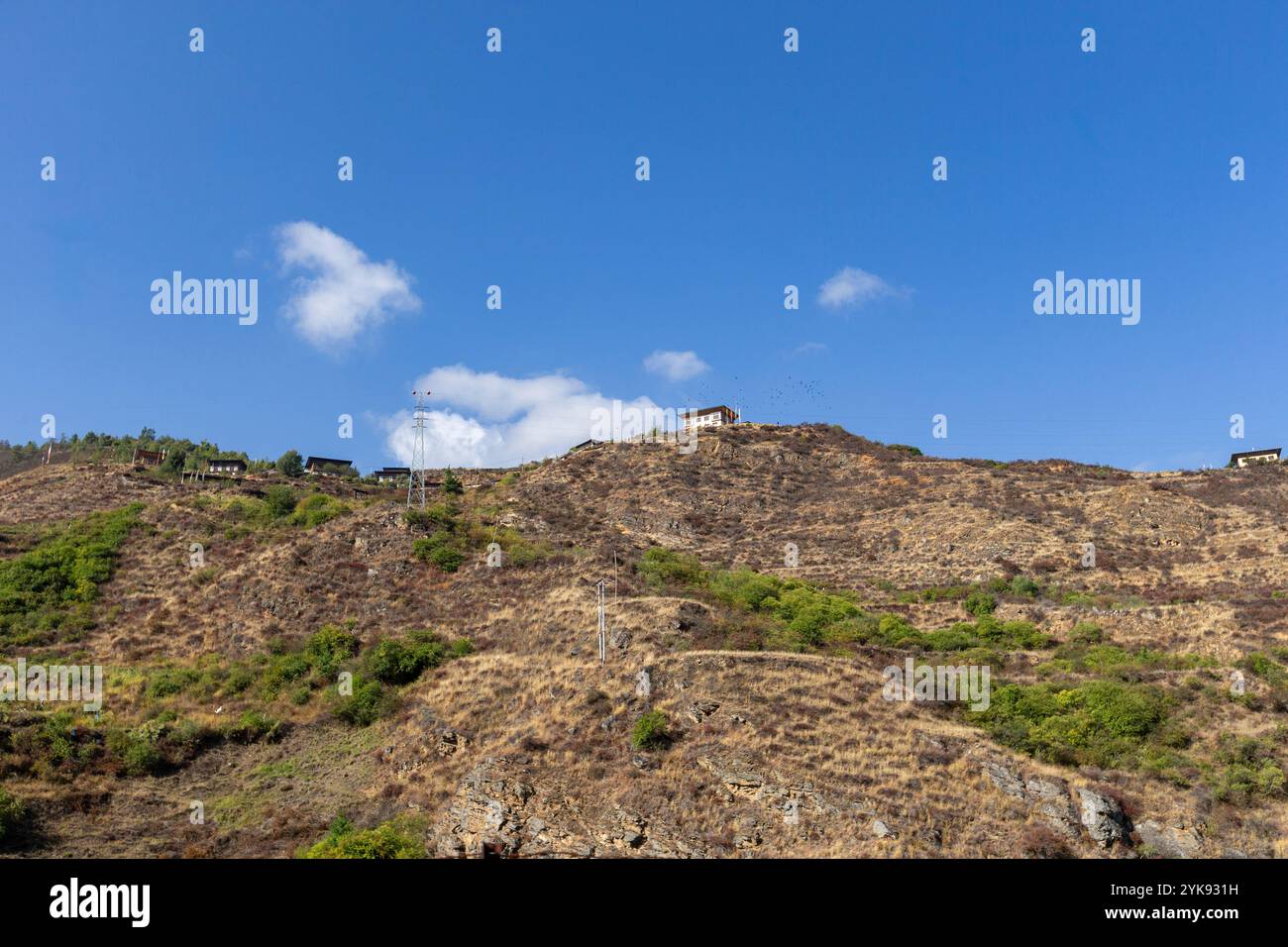 Traditional Bhutanese building complex nestled on a hillside, Paro ...