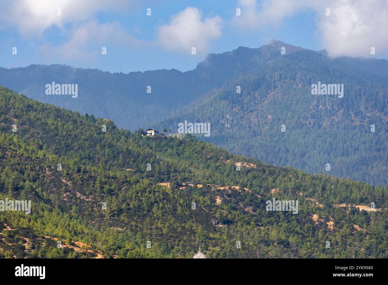Traditional Bhutanese building complex nestled on a hillside, Paro ...