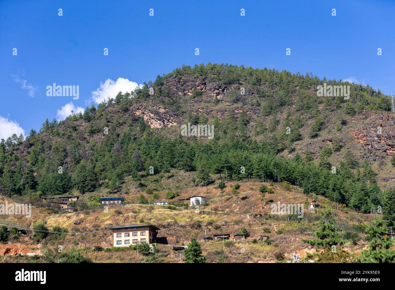 Traditional Bhutanese building complex nestled on a hillside, Paro ...