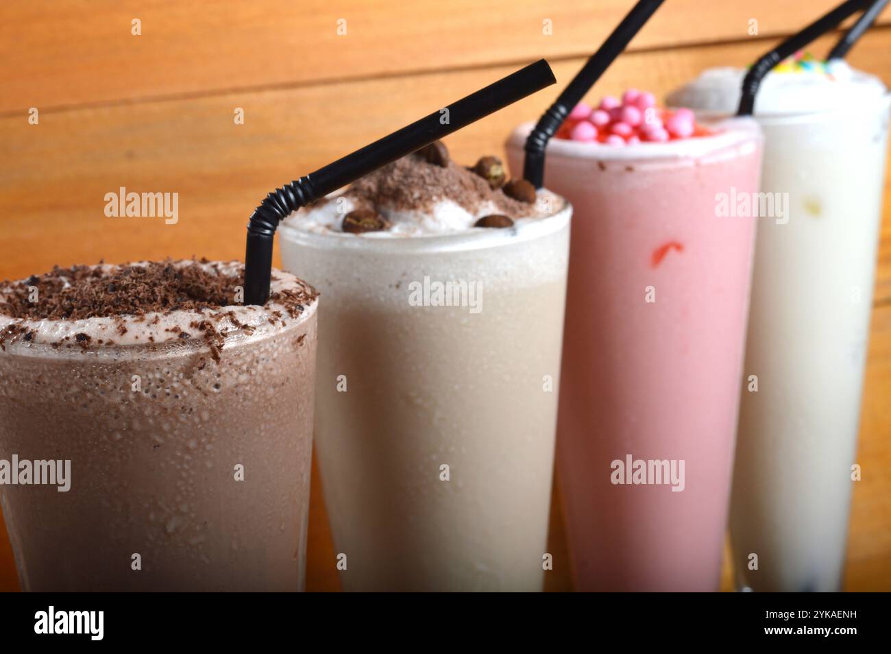 four types of milkshake drink on wooden board Stock Photo - Alamy