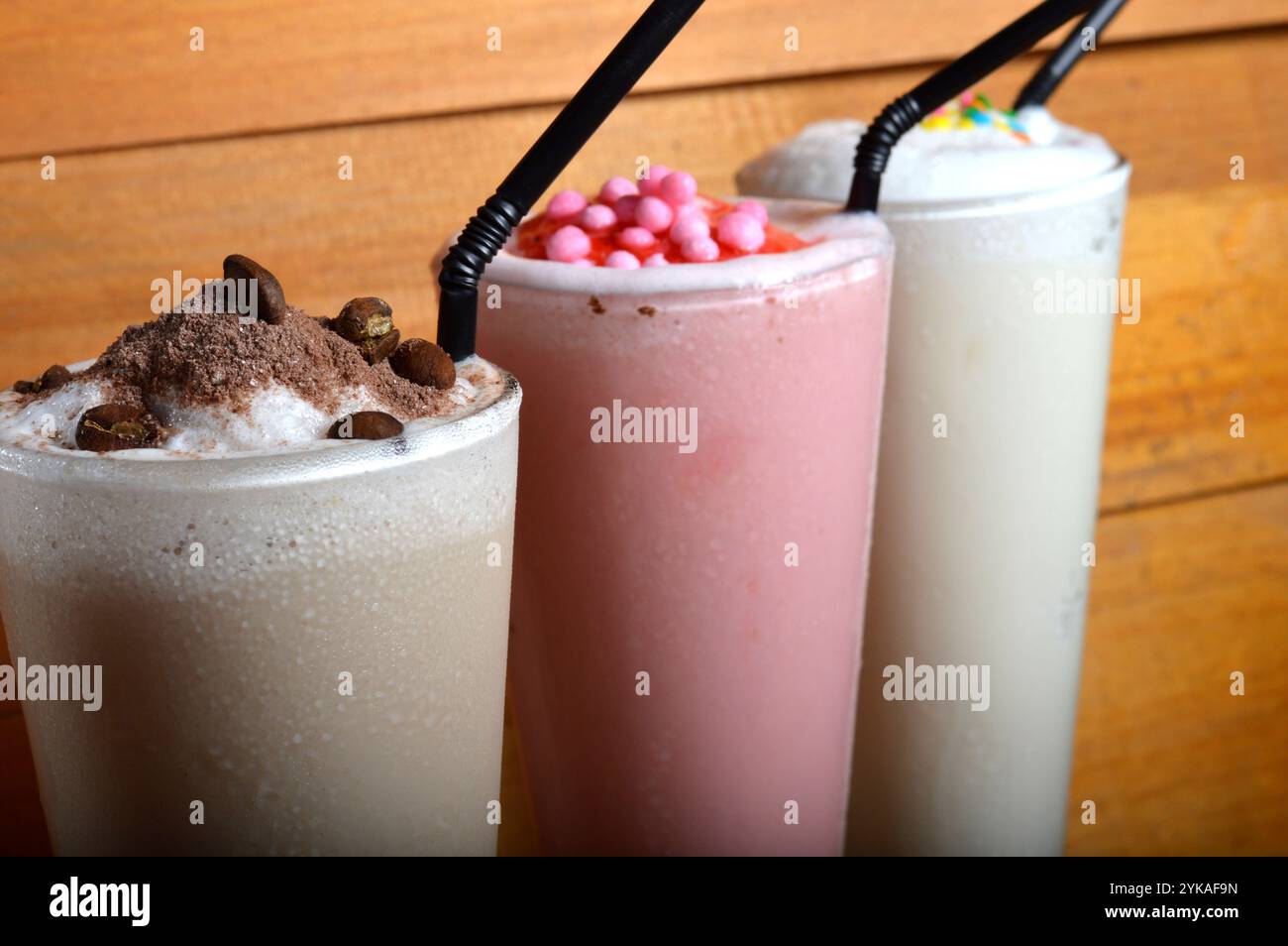 four types of milkshake drink on wooden board Stock Photo - Alamy