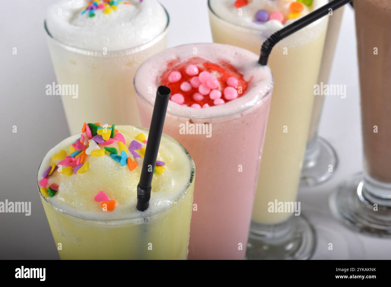 four types of milkshake drink on white background Stock Photo - Alamy