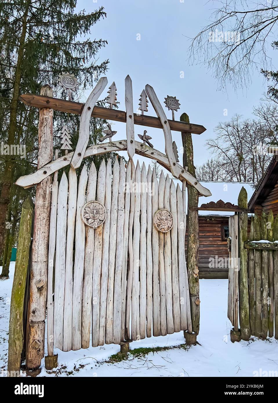The timber gate, decorated with carved sculptures, leading to the ...